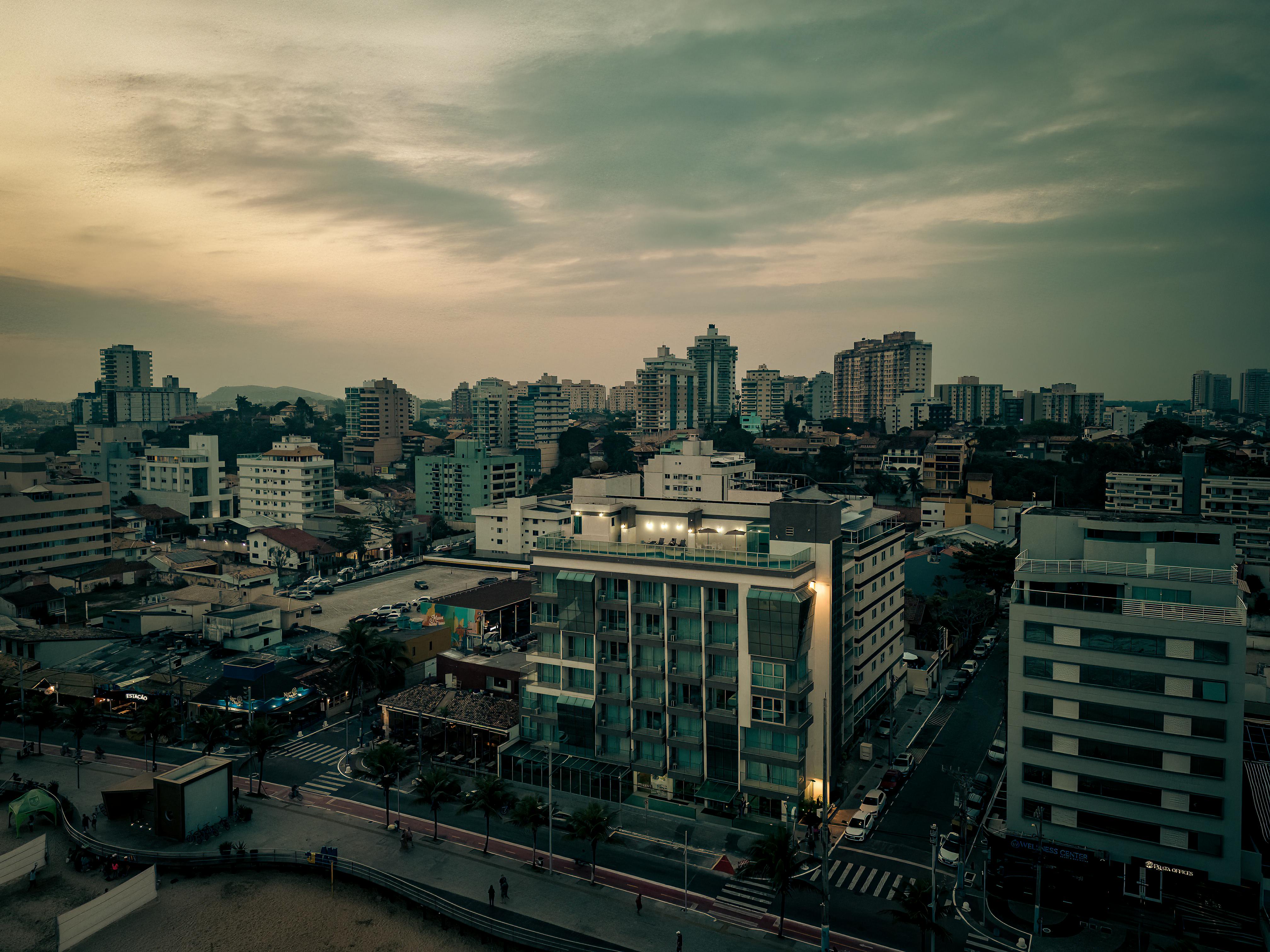 Black High Rise Building Under Grey and White Sky during Night Time ...