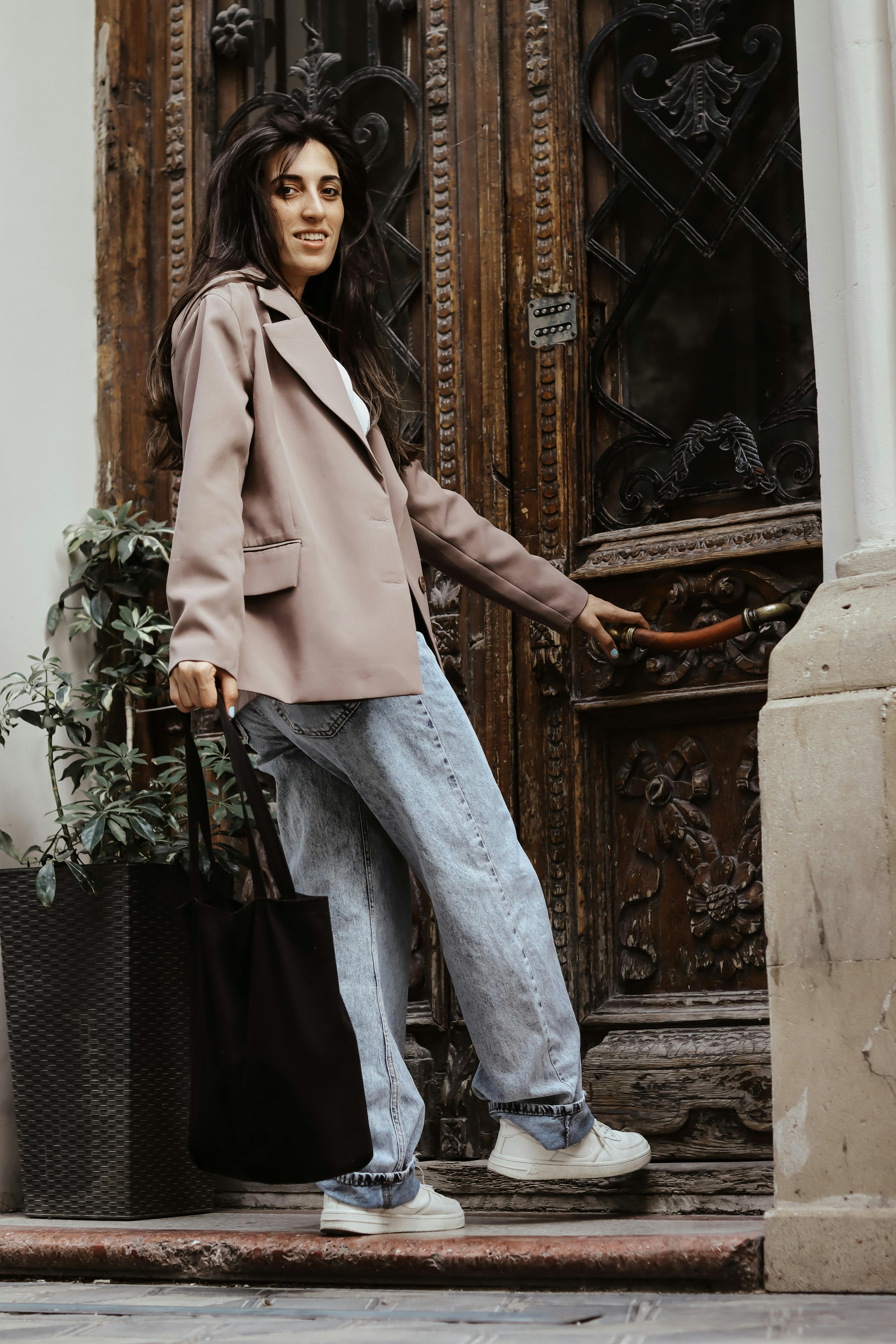 Portrait of a Woman Standing by a Door · Free Stock Photo