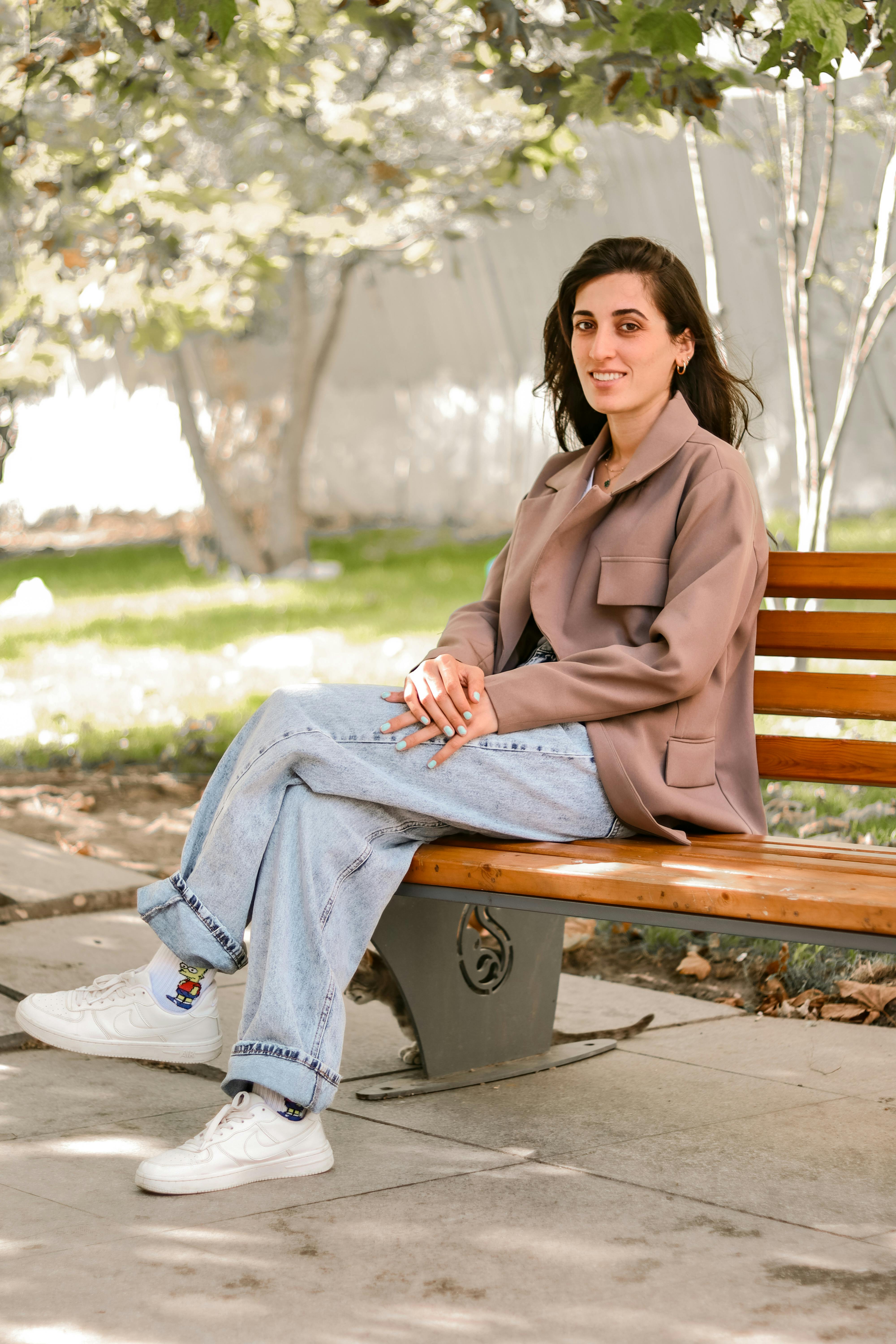 Beautiful Woman Sitting on a Park Bench · Free Stock Photo