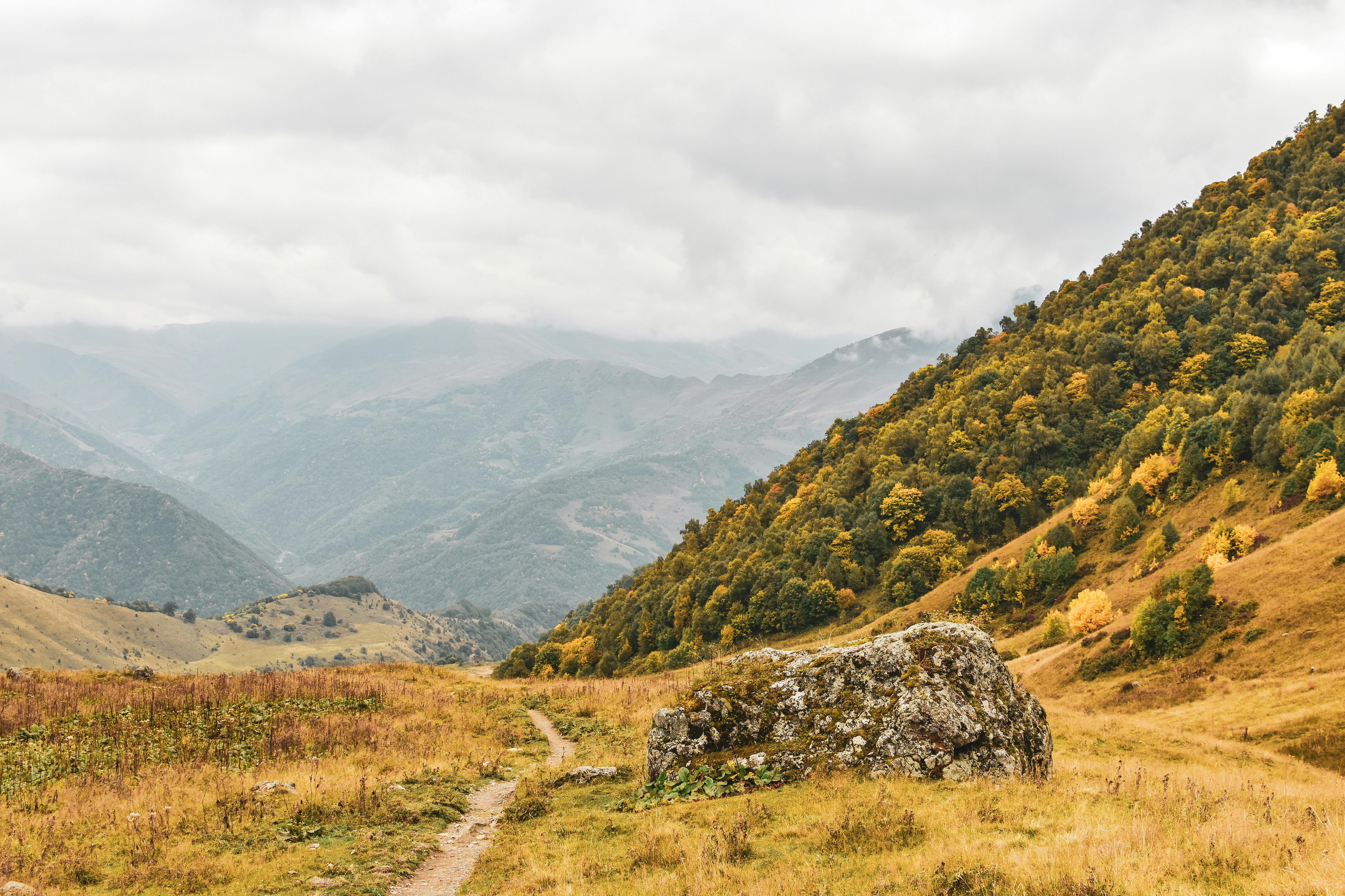 Rock by a Path Leading Through a Mountain Valley · Free Stock Photo