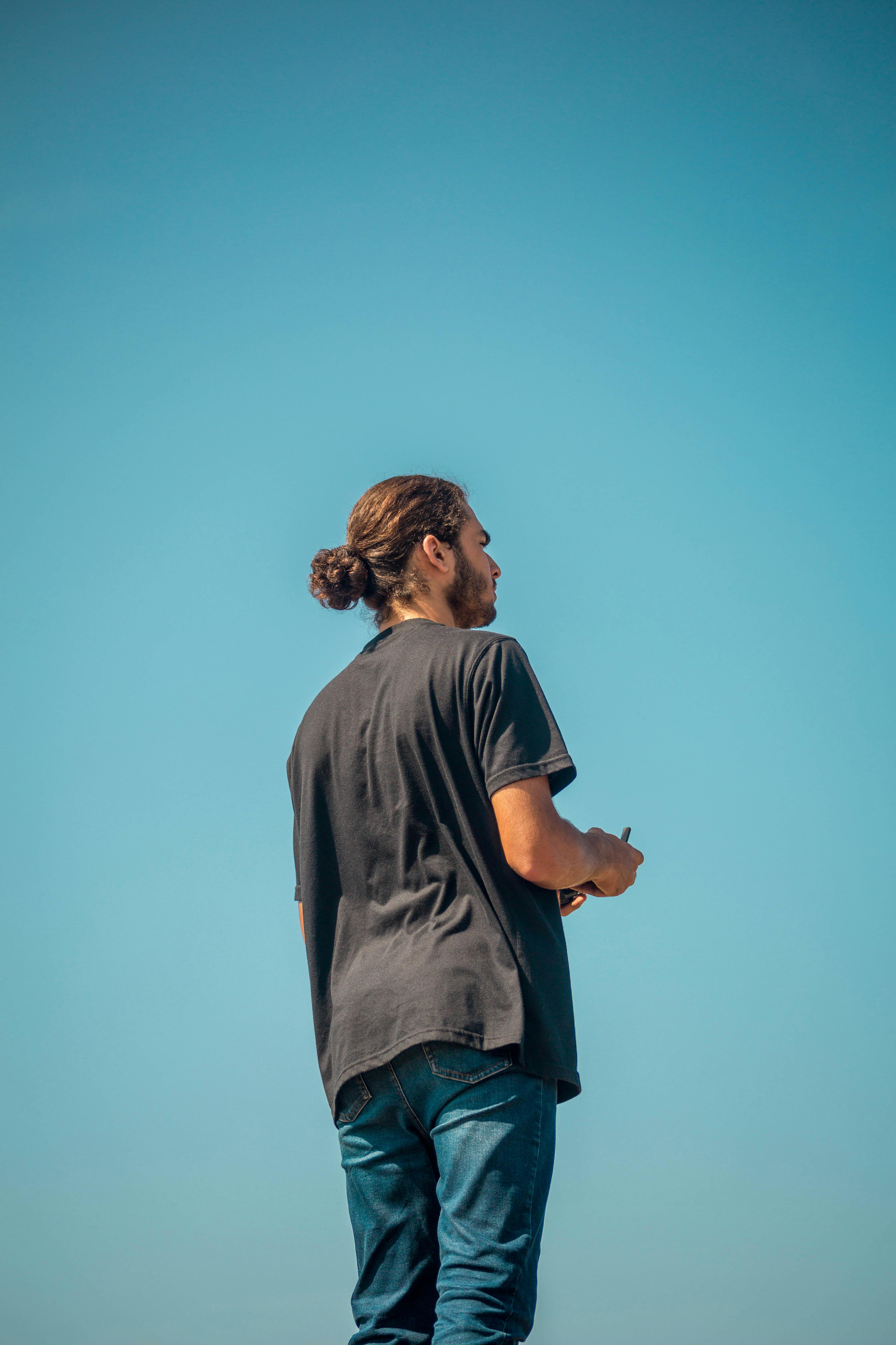 Back of a Man Standing Against the Sky · Free Stock Photo