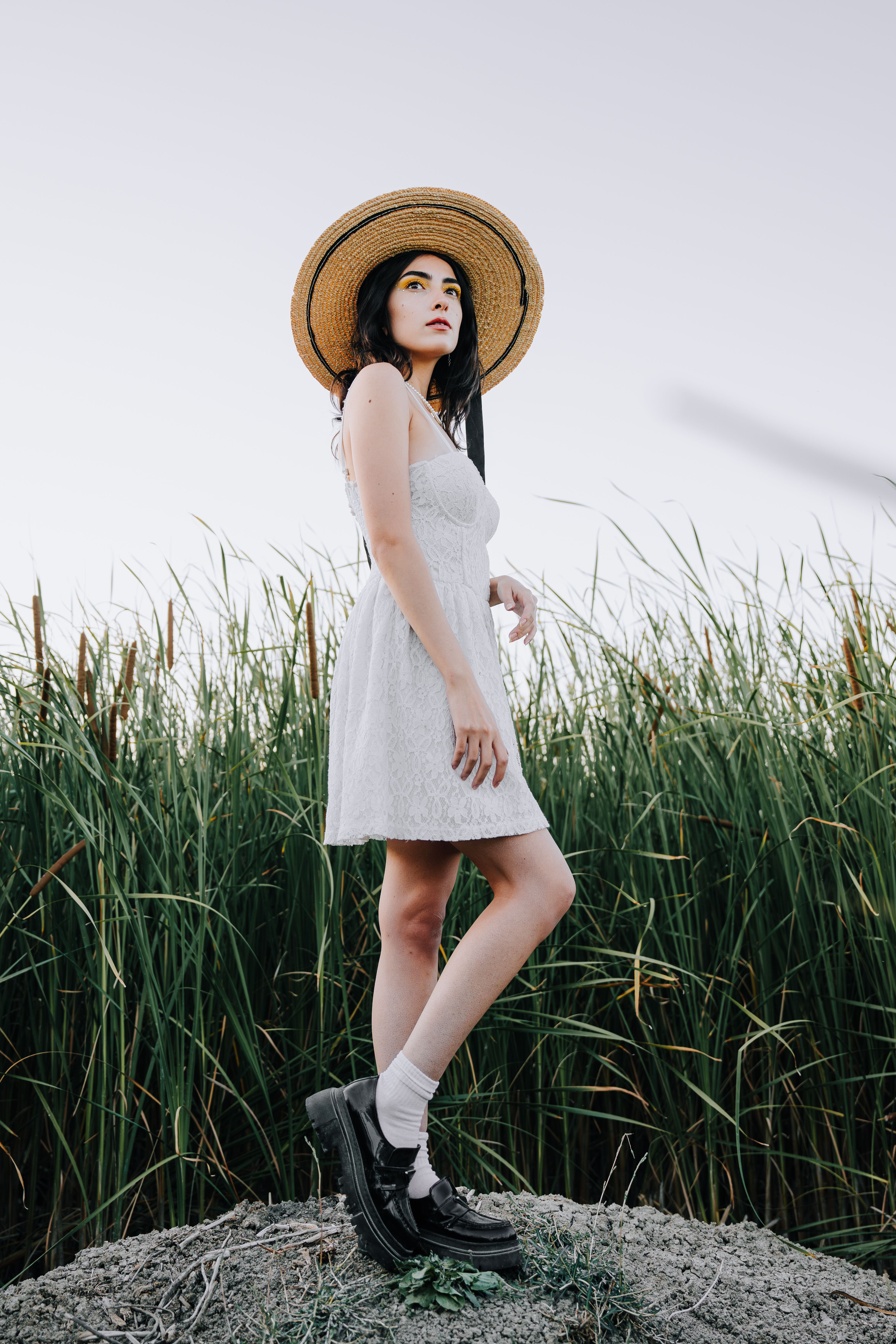 Female Model Wearing a White Dress Standing on a Mound in a Summer ...