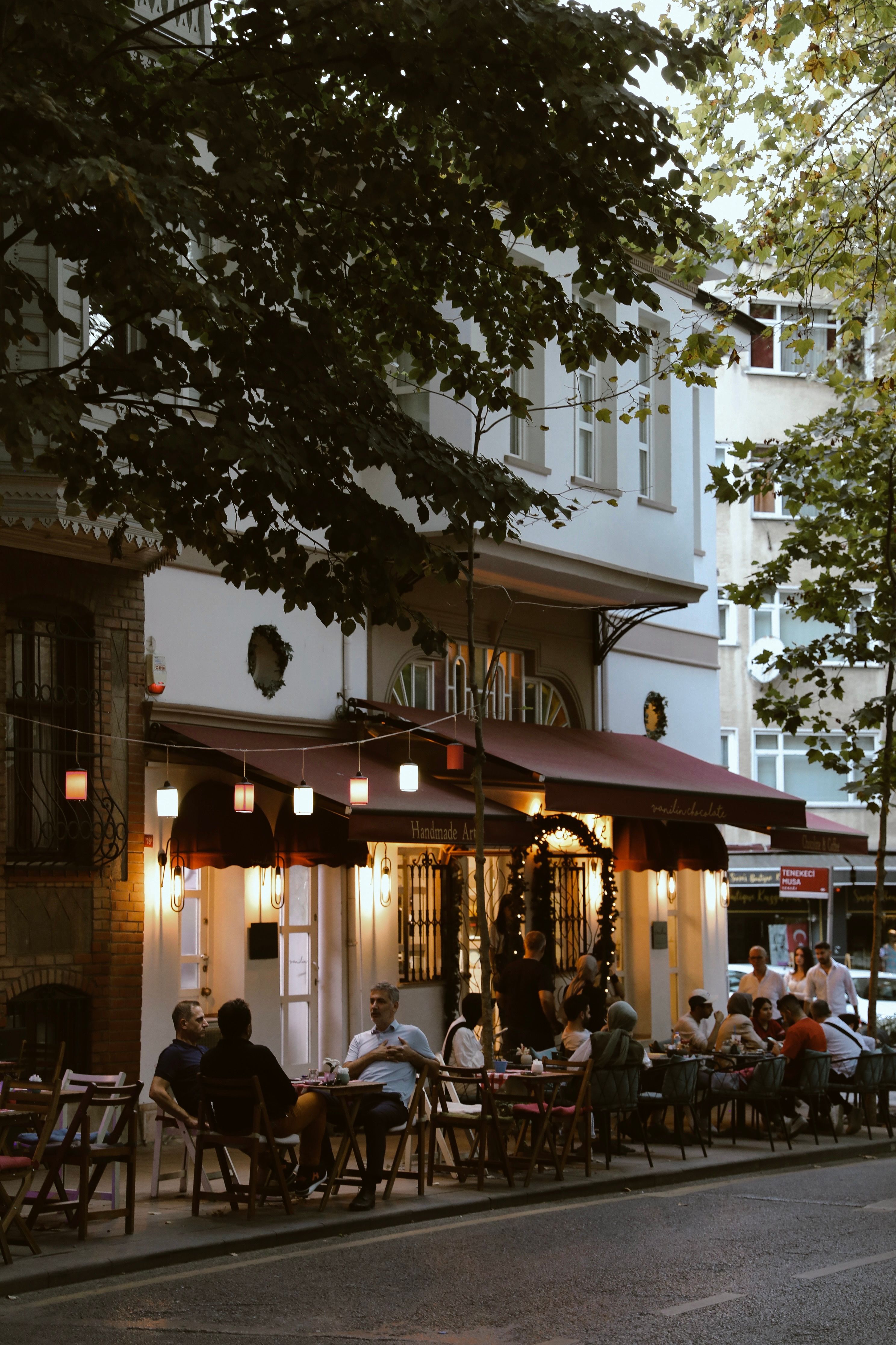 People Sitting at the Tables in a Restaurant Patio · Free Stock Photo