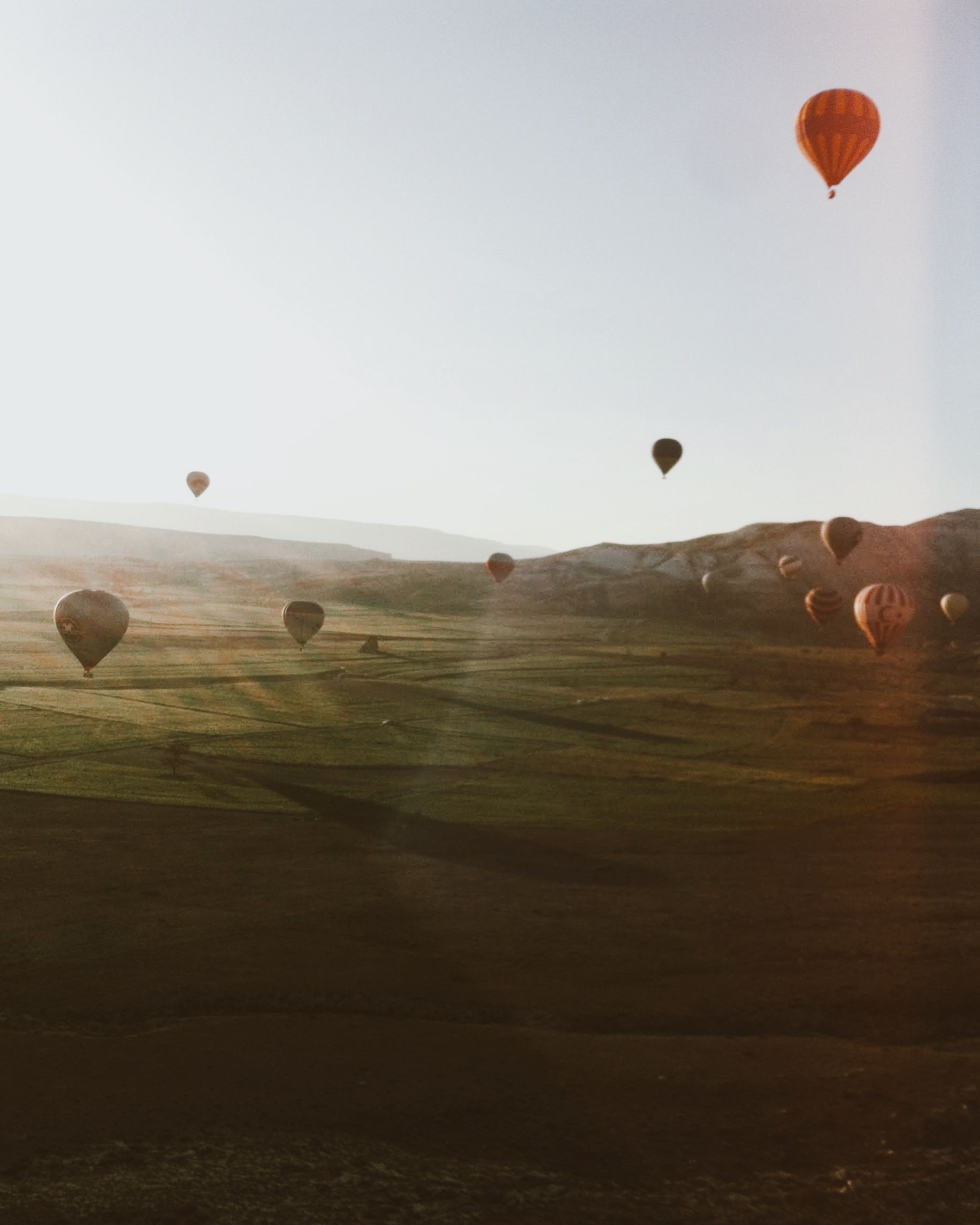 Hot Air Balloons Floating over Rural Landscape · Free Stock Photo