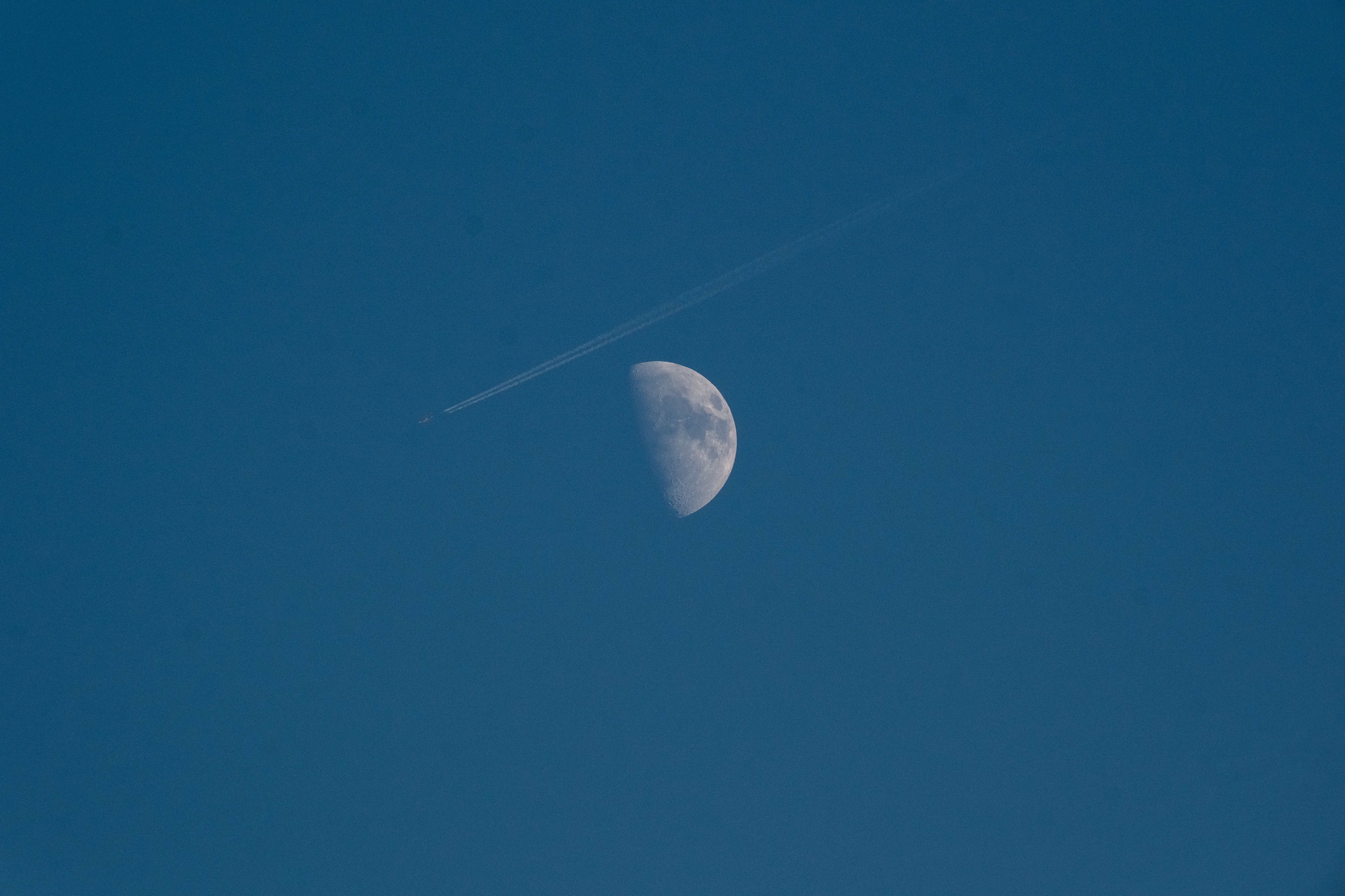 An Airplane Passing the Moon in the Sky · Free Stock Photo