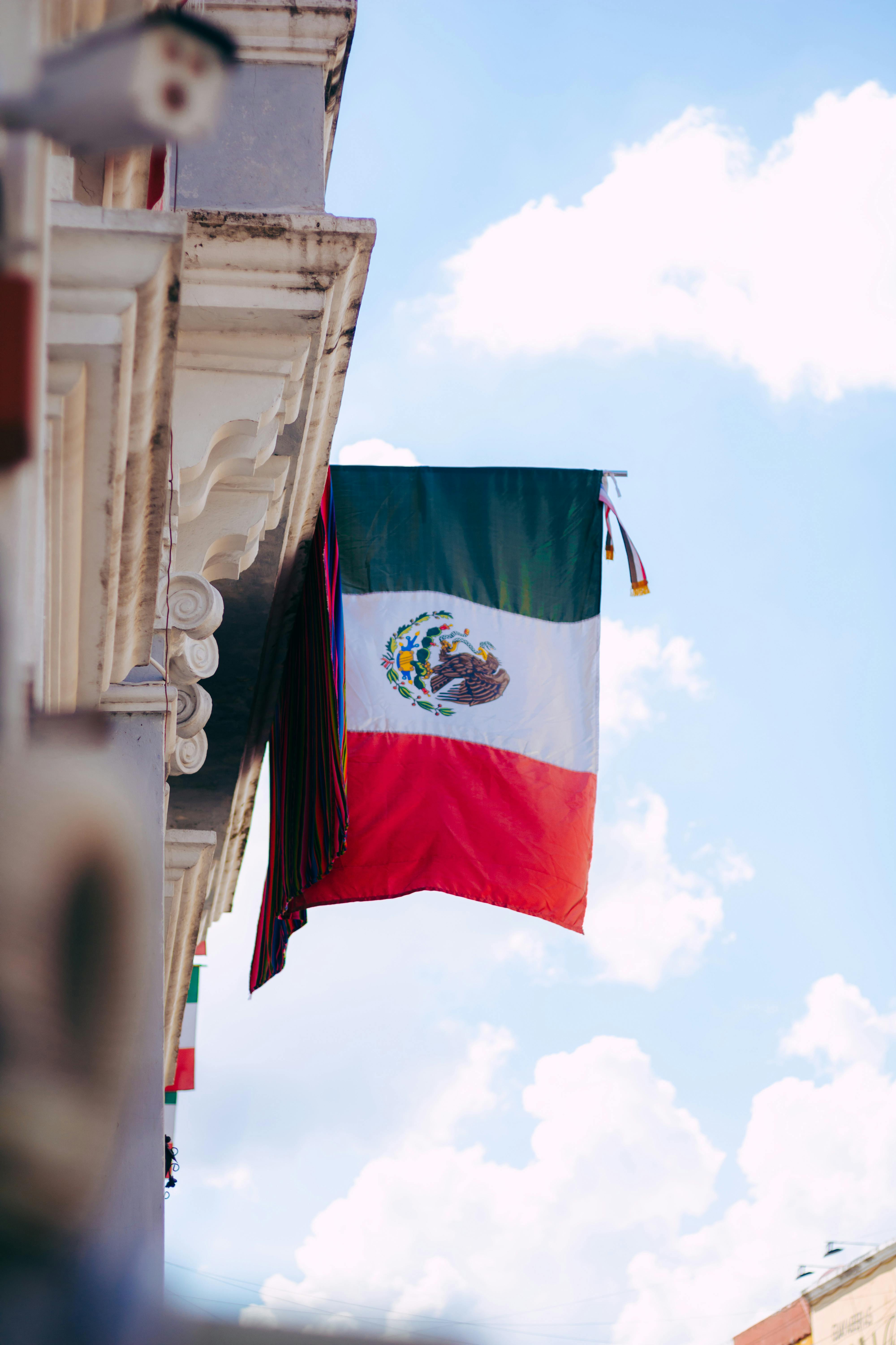 Mexican Flag Hanging on a Building · Free Stock Photo