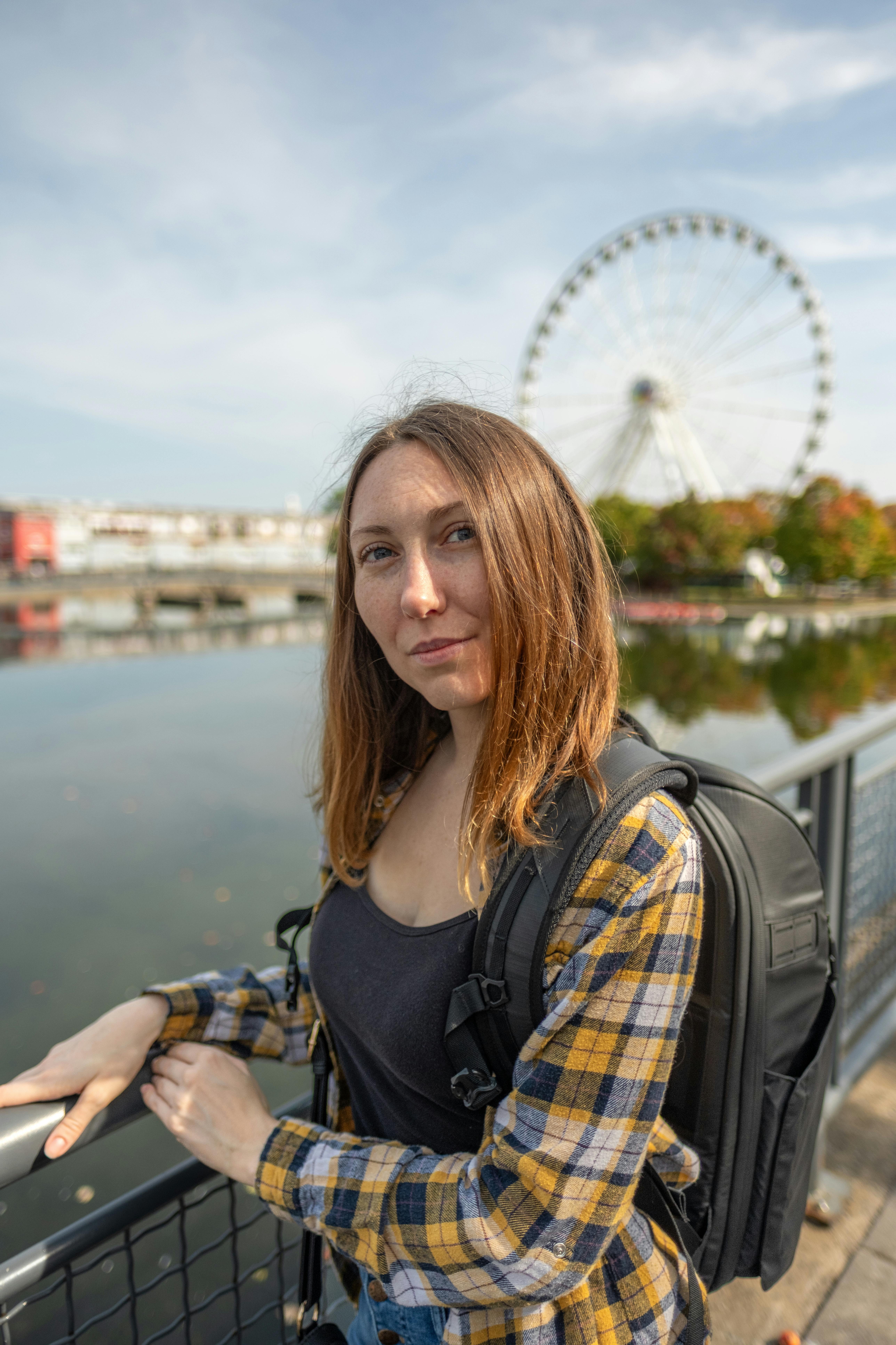 Woman with Backpack Standing on Footbridge on River · Free Stock Photo