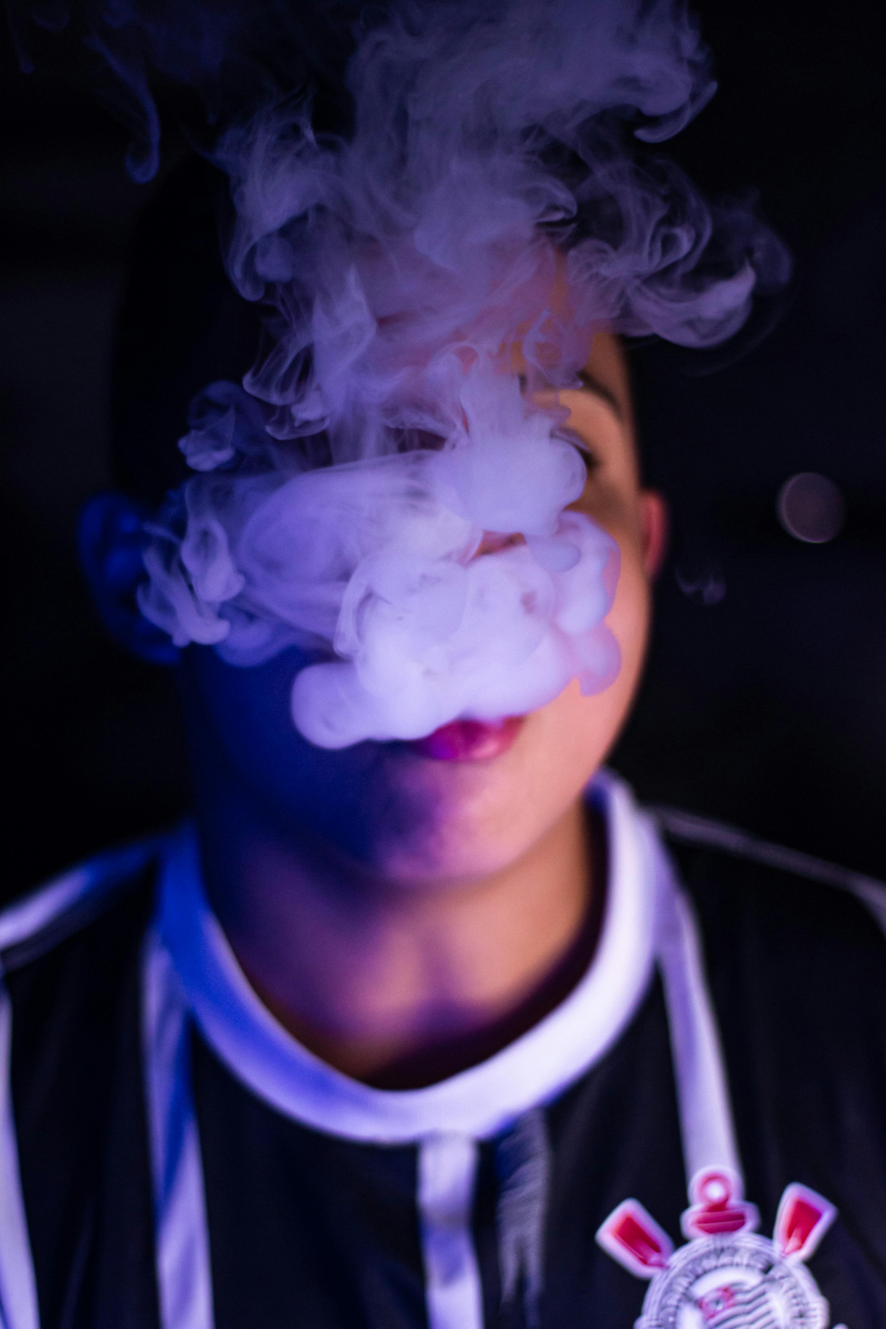 Head of a Person Exhaling Smoke · Free Stock Photo
