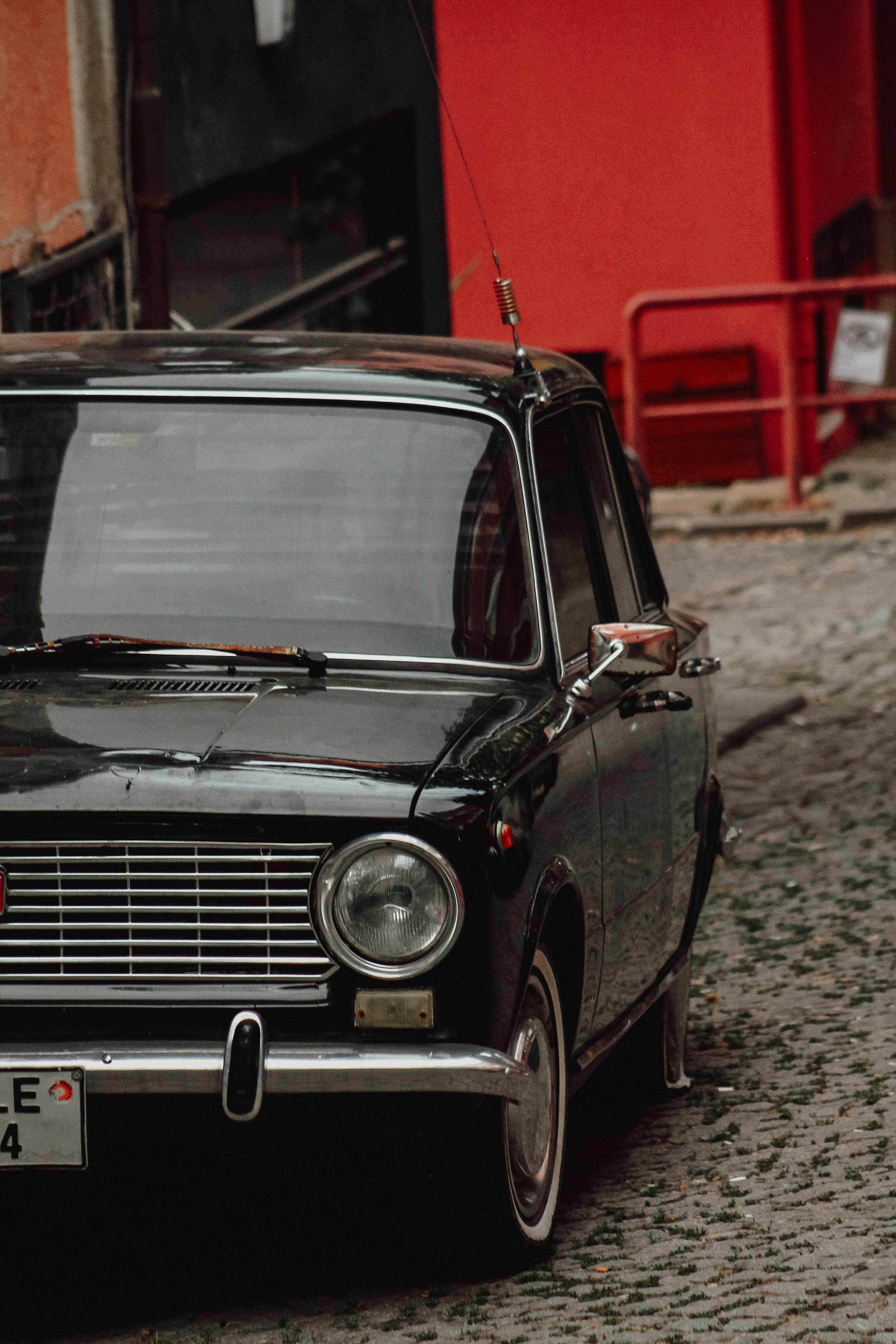 Vintage Red Car in Urban Street Scene · Free Stock Photo