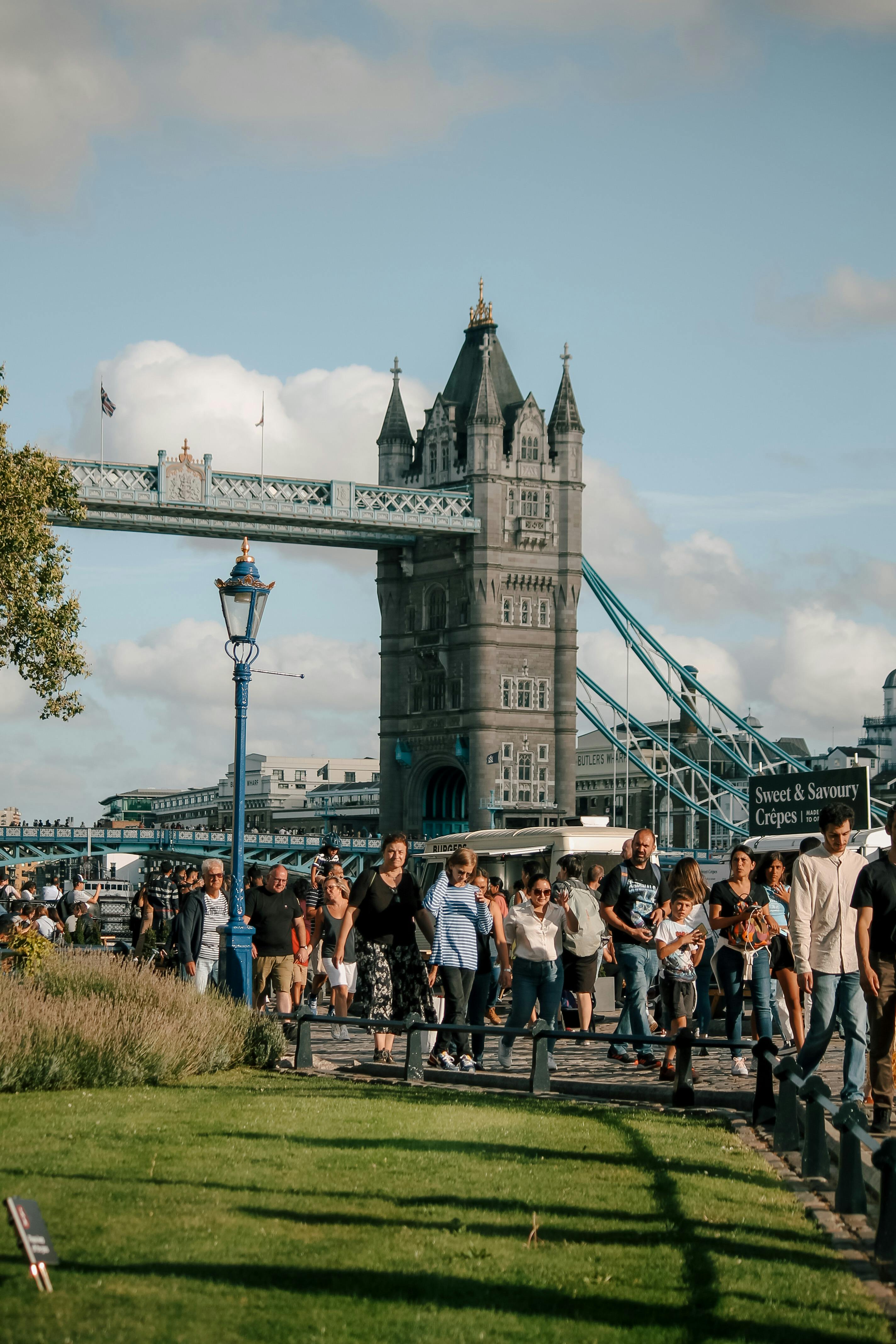 Crowd Walking Down Street Against Tower Bridge · Free Stock Photo