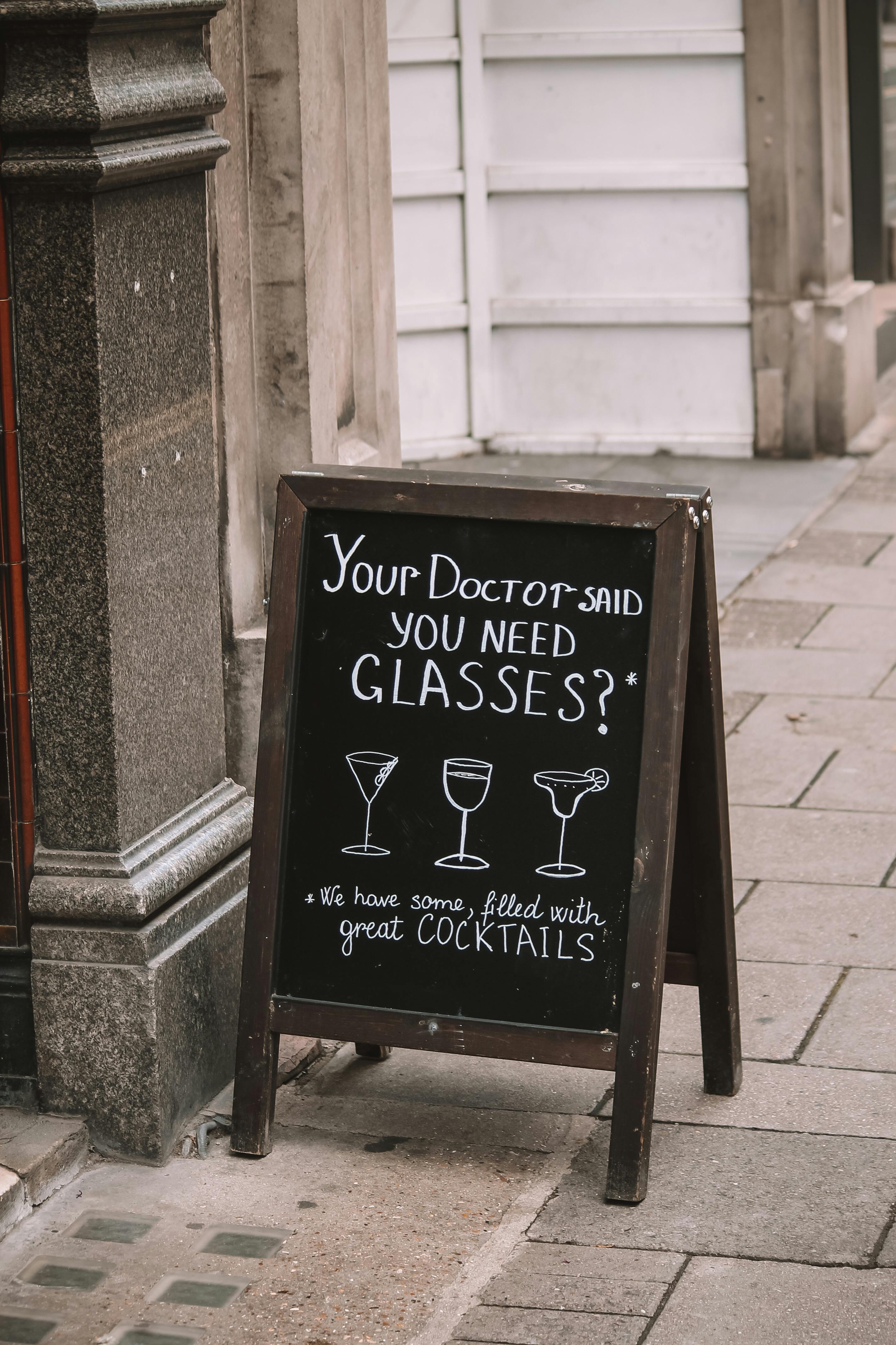 Standing Board with a Written Text by a Bar on the Street · Free Stock ...