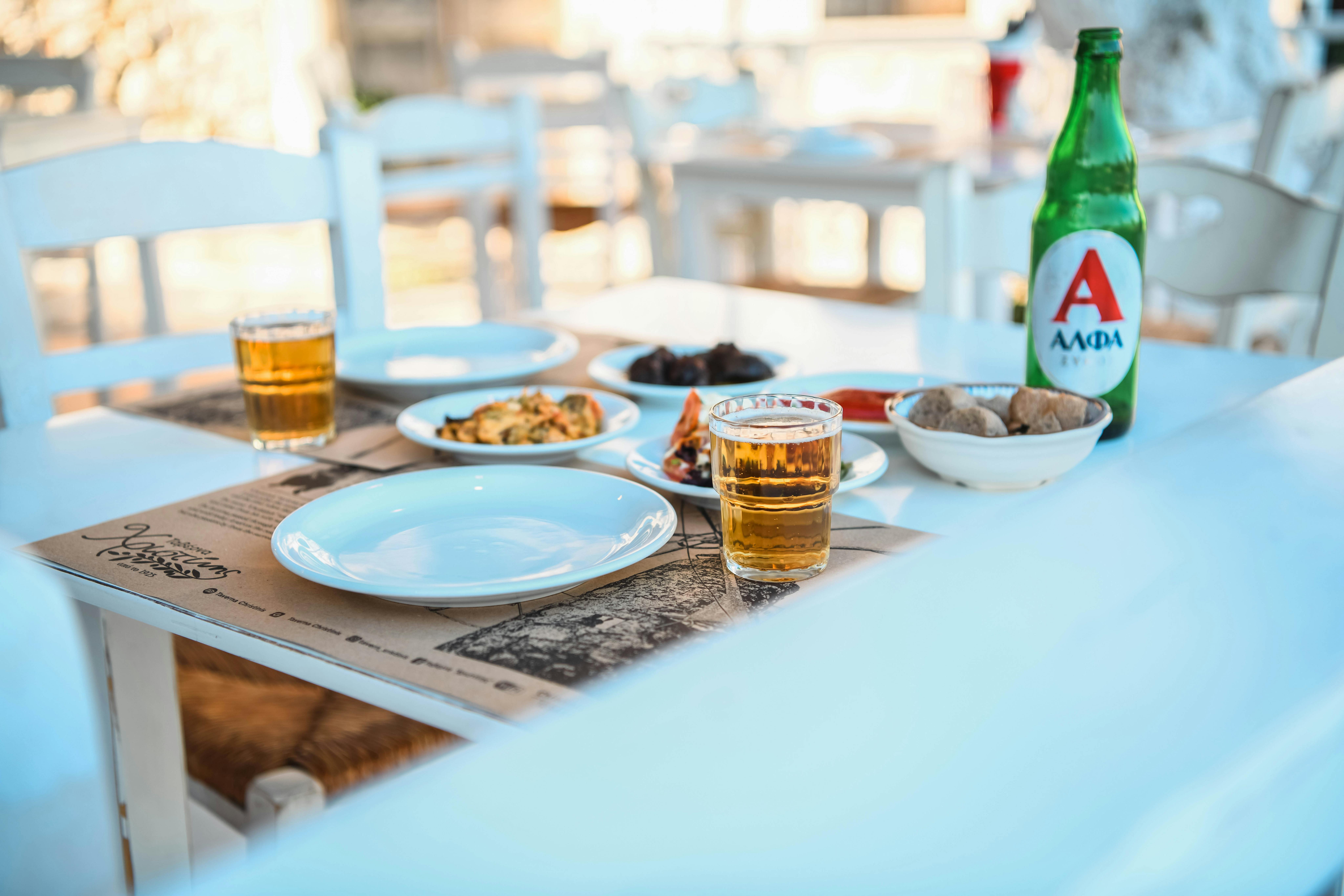 Food and a Bottle of Beer Standing on a Table · Free Stock Photo