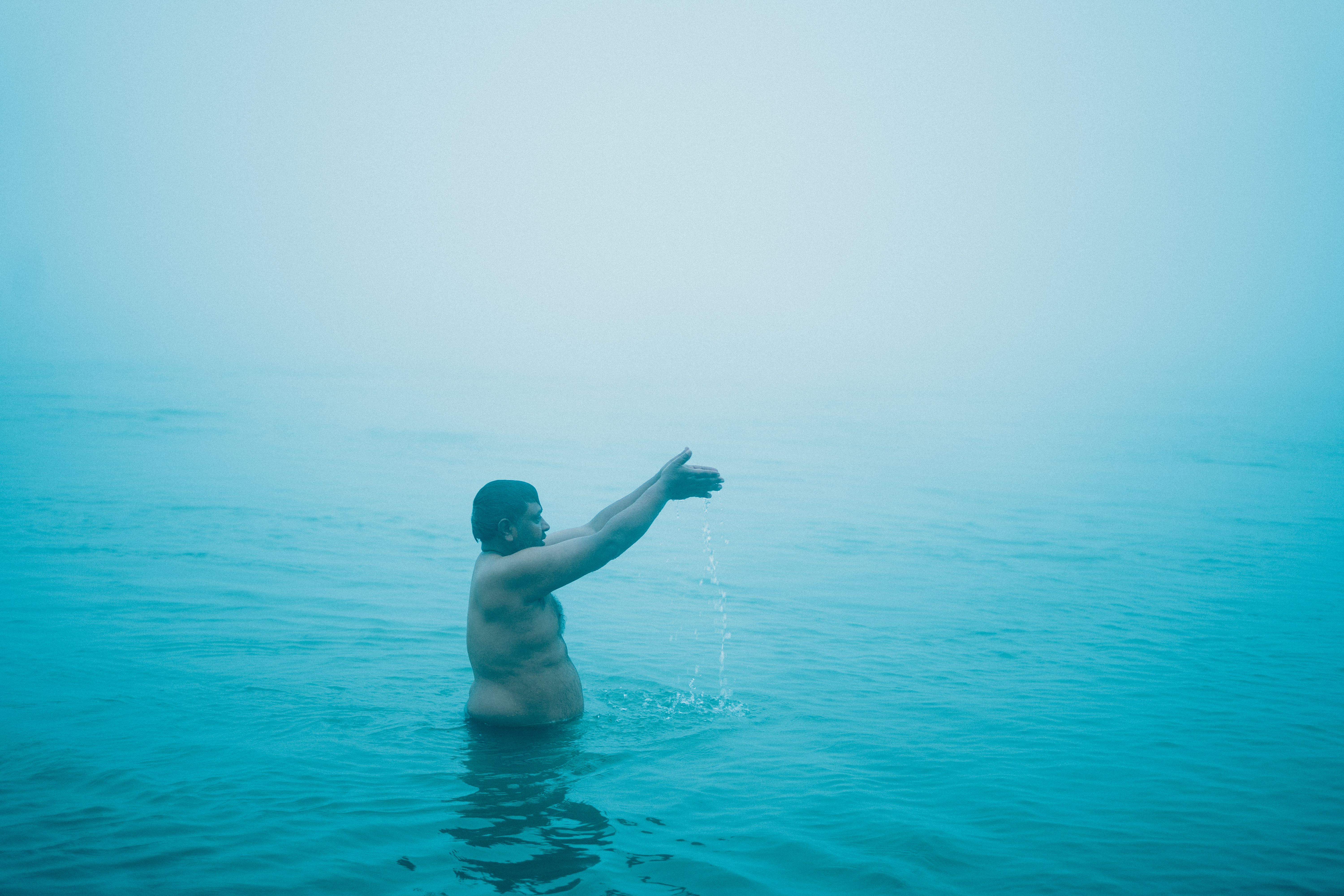 Man Standing in the River Splashing Water · Free Stock Photo