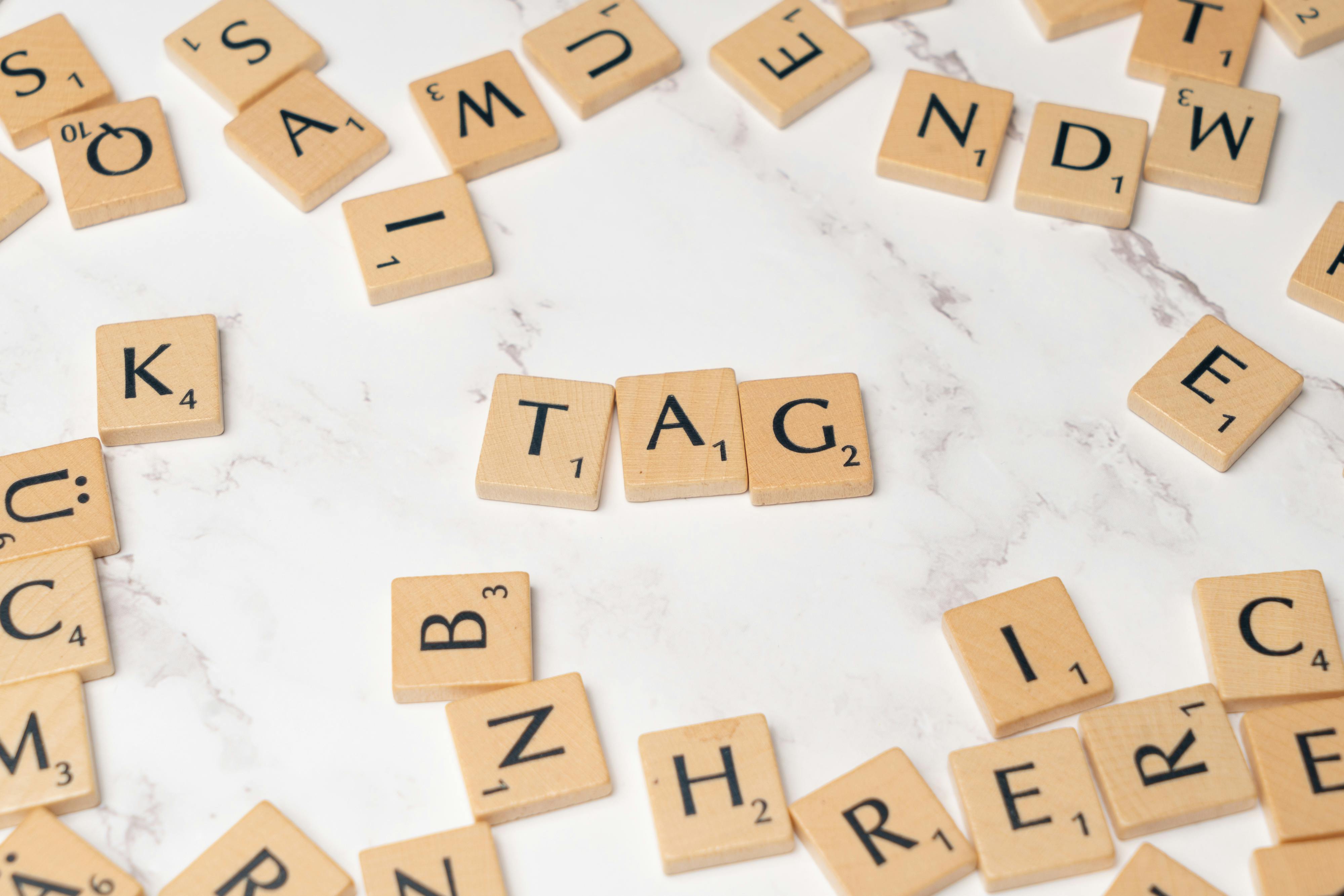 Tag scrabble letters on a marble surface · Free Stock Photo
