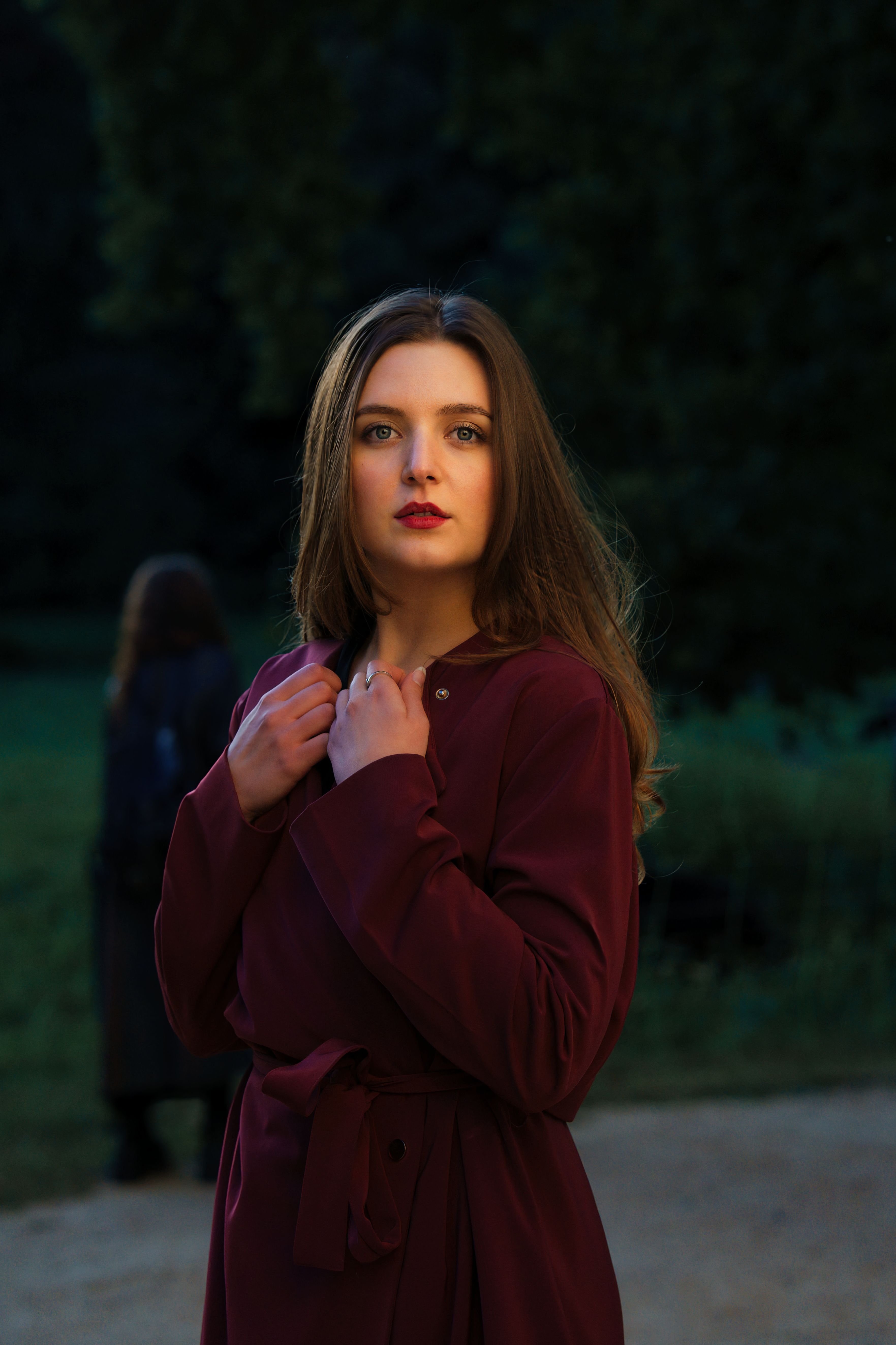 Portrait of a Female Model Wearing a Red Overcoat · Free Stock Photo