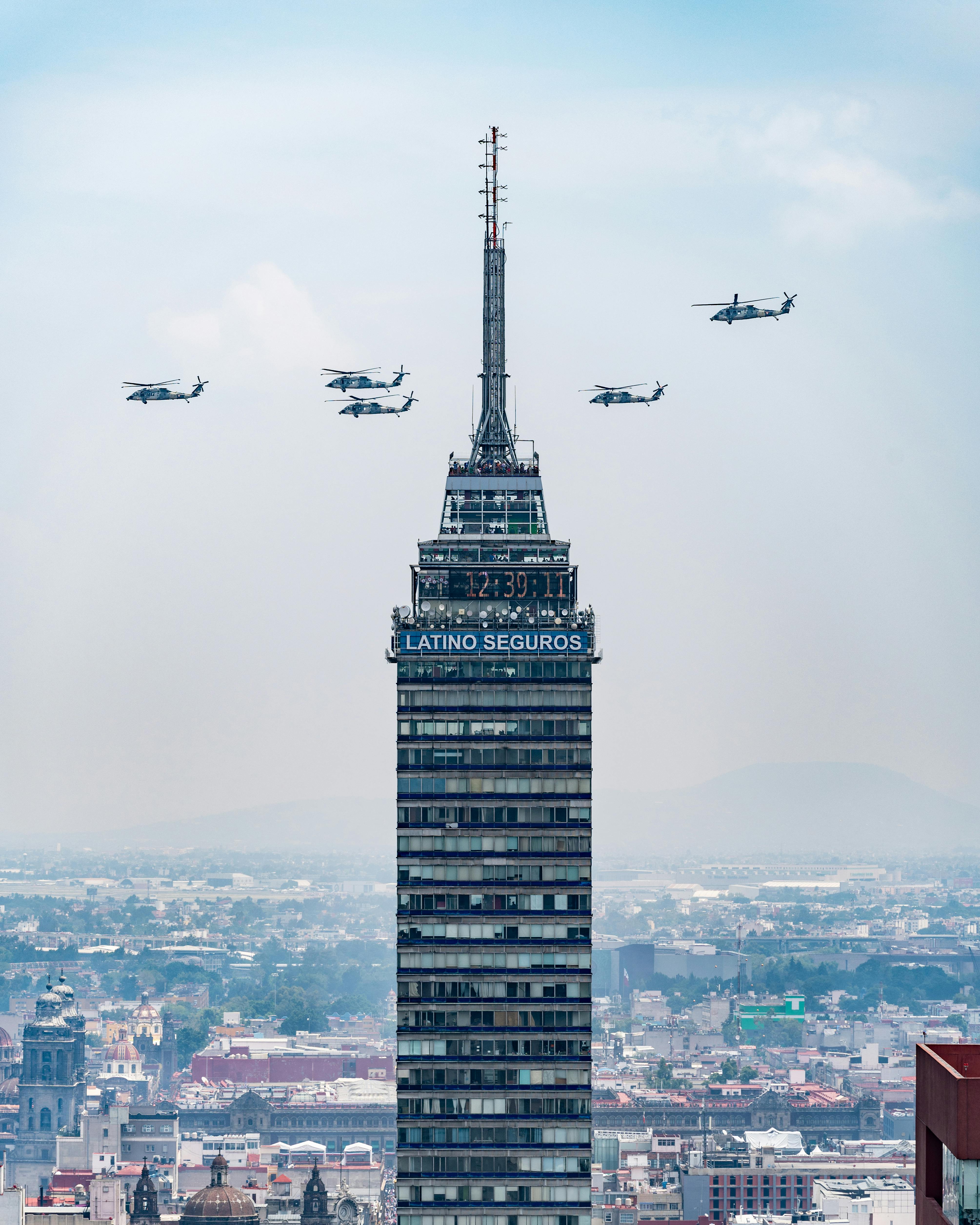 A group of military planes flying over a tall building · Free Stock Photo