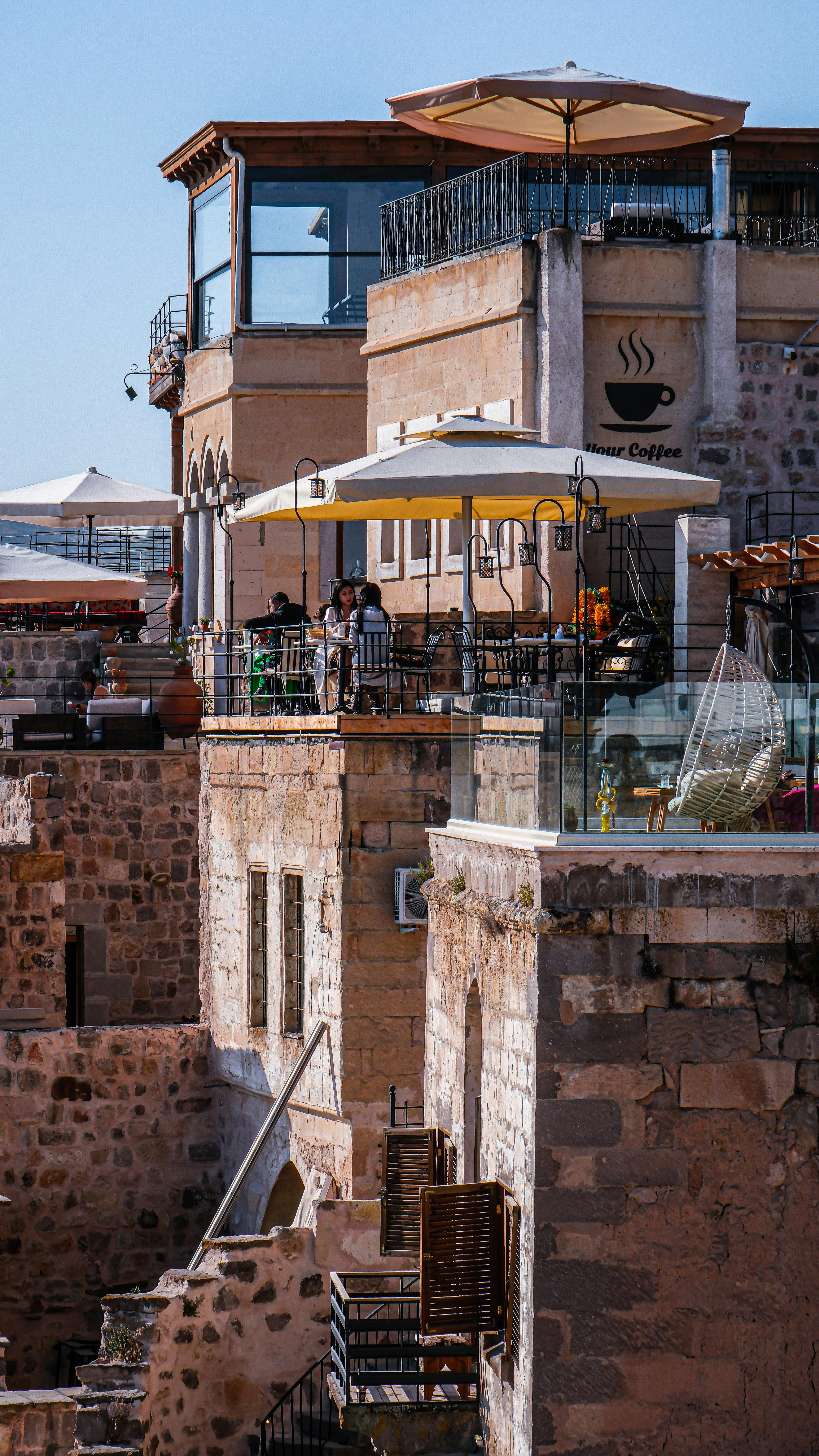 People Relaxing on a Cafe Balcony · Free Stock Photo
