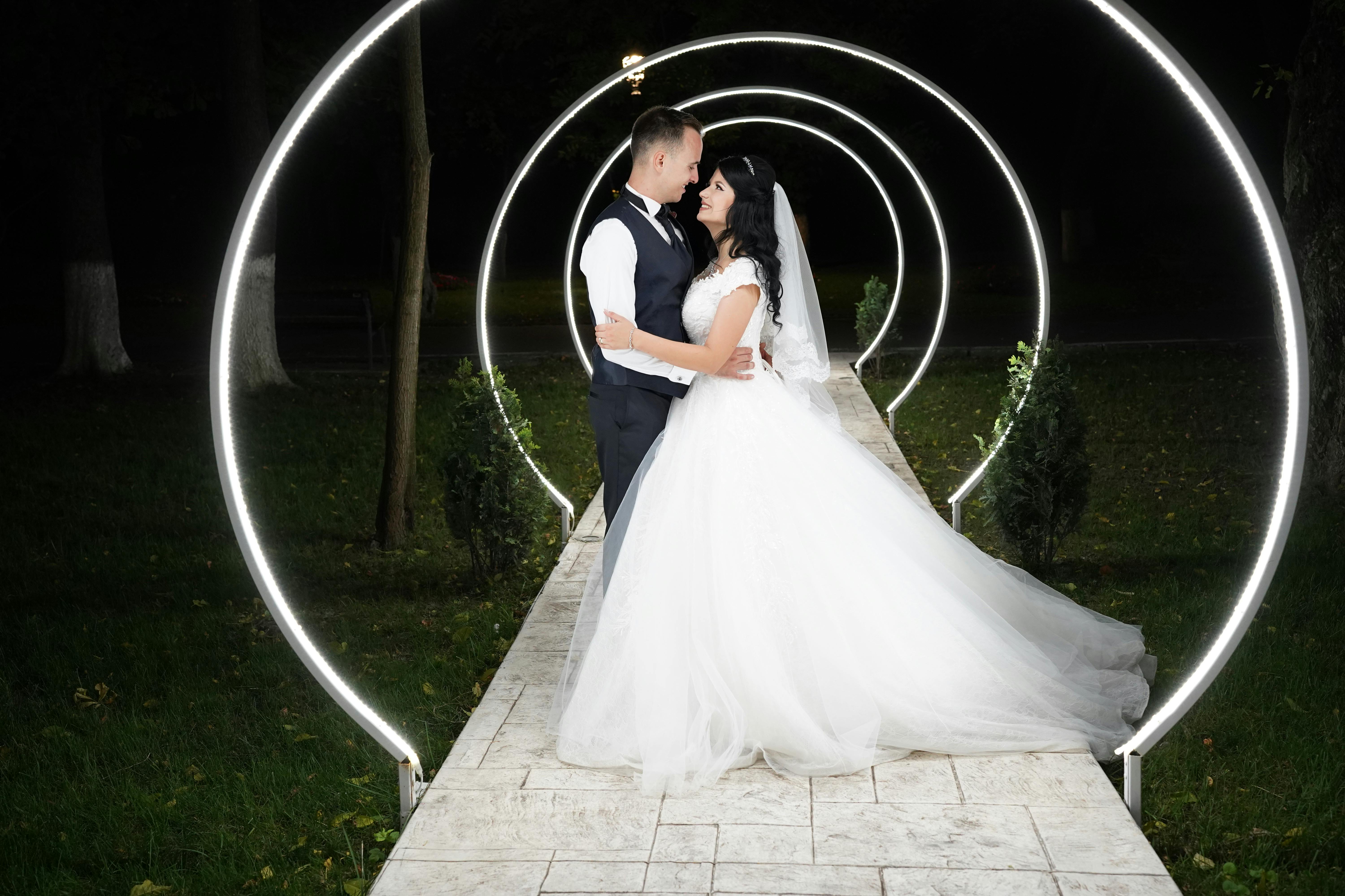 Lights over Smiling Newlyweds at Night · Free Stock Photo