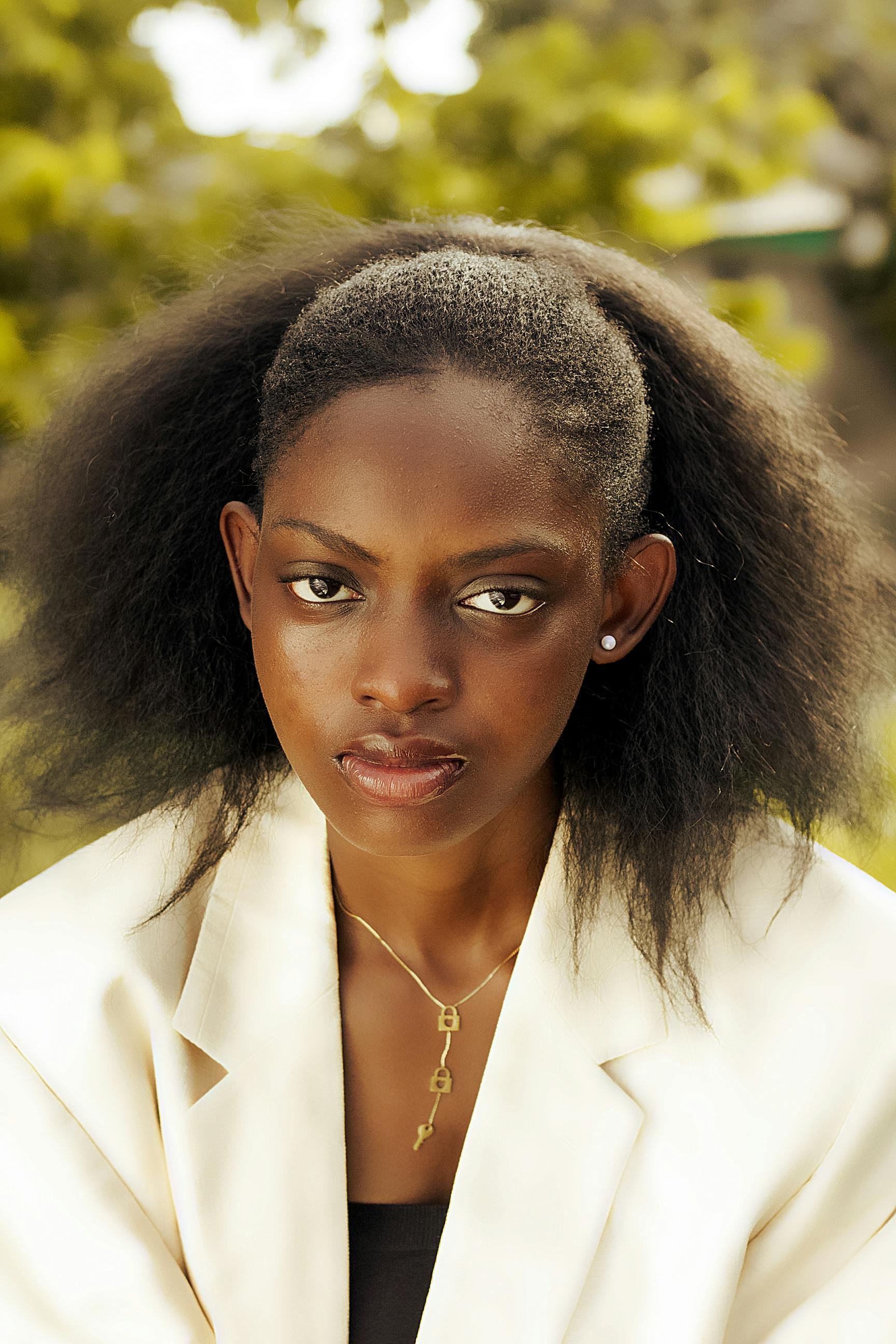 Young Woman Posing in Elegant White Blazer and Golden Necklace · Free ...