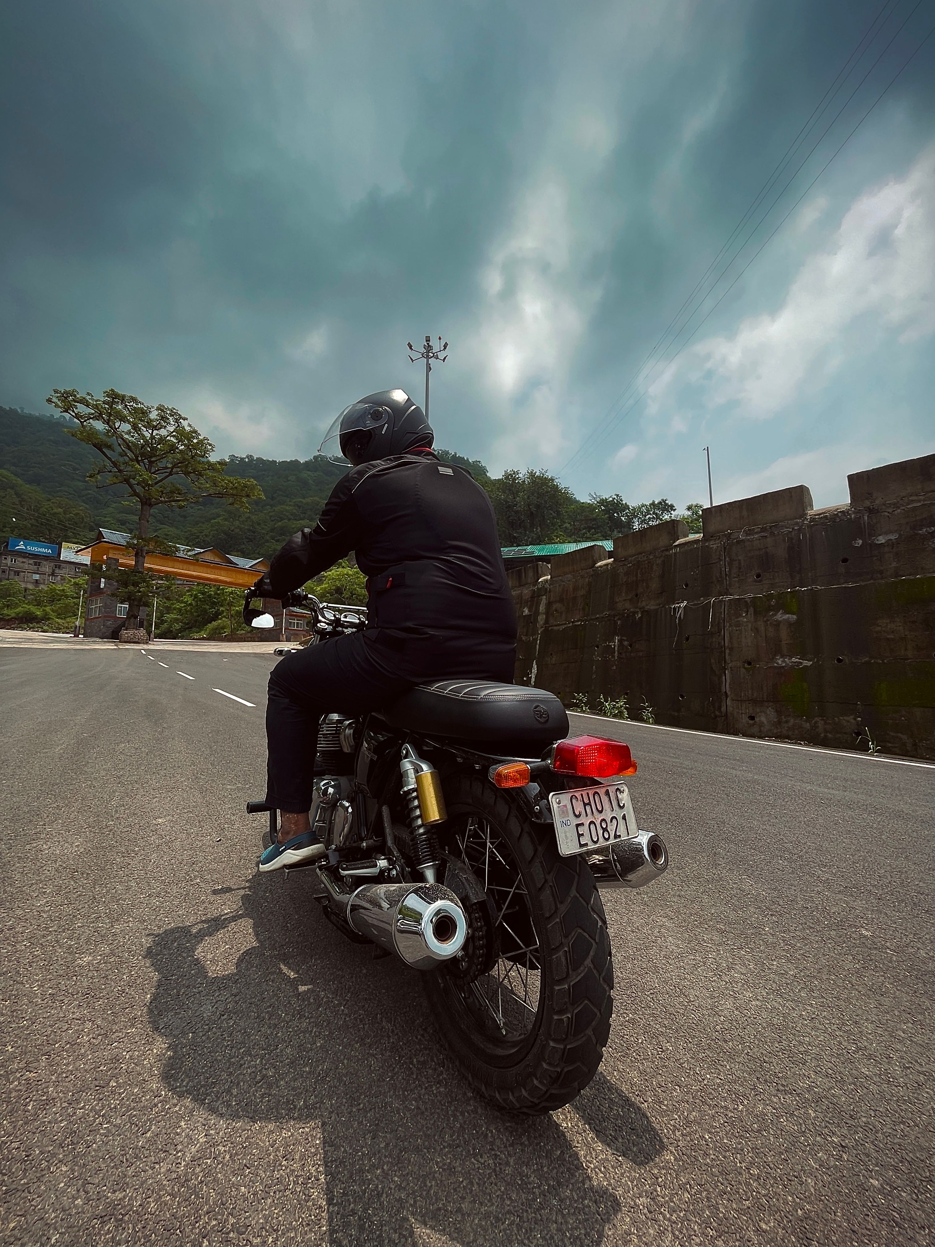 Photo of Man Sitting on Motorcycle Near Tower · Free Stock Photo