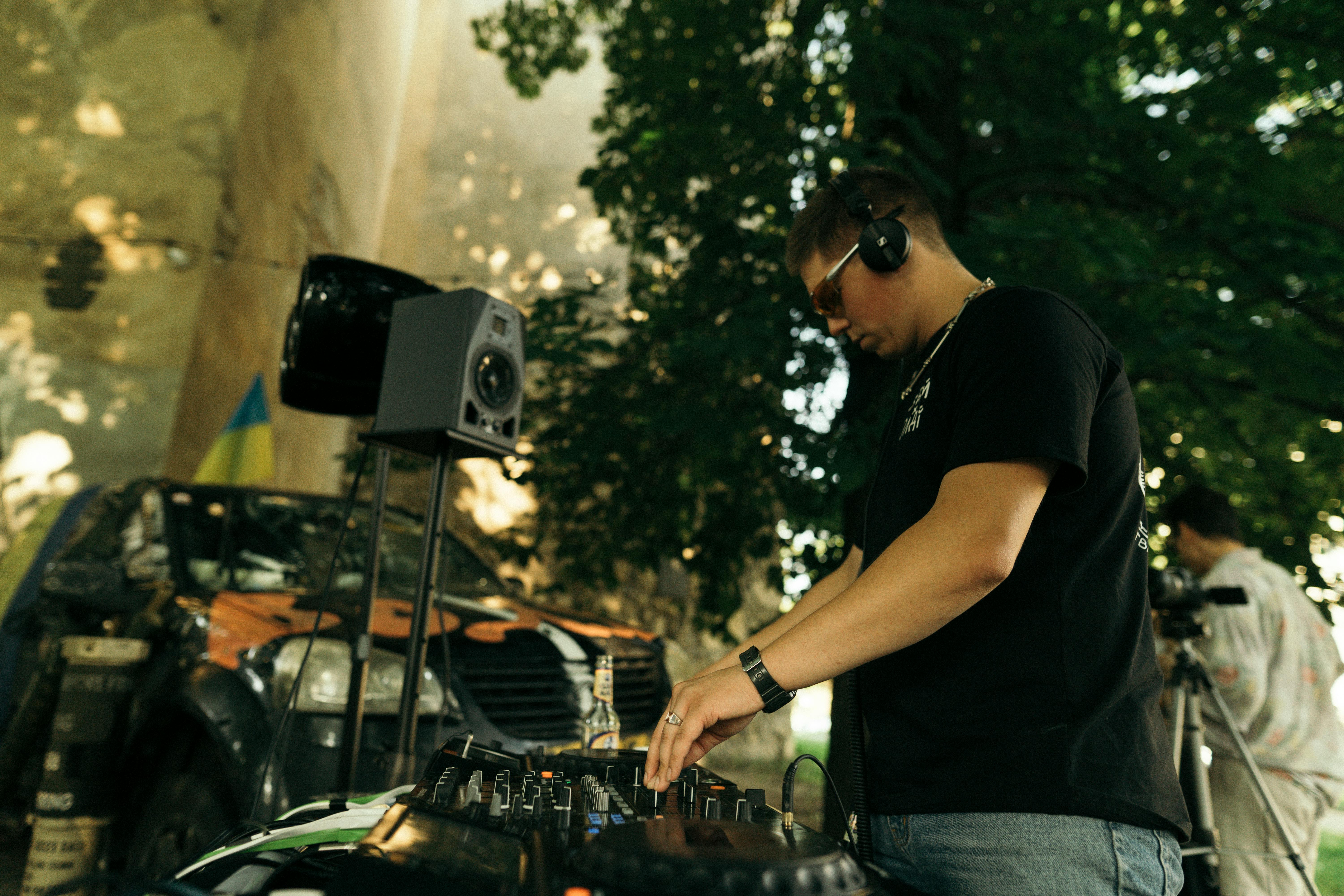 A DJ Using a Console to Play Music Outside · Free Stock Photo