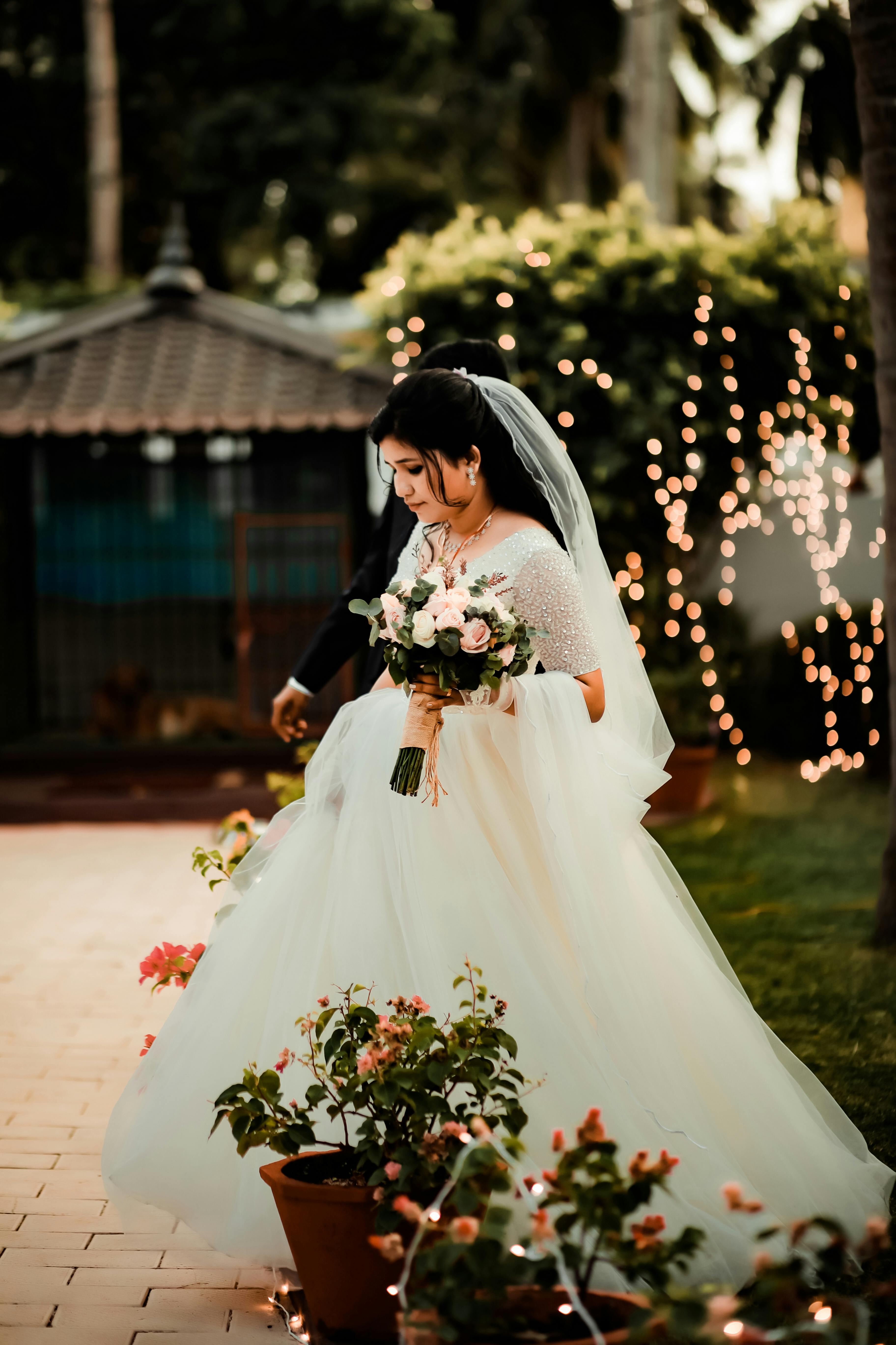 Bride Standing in Front Green Leaf Plant While Holding Bouquet · Free ...
