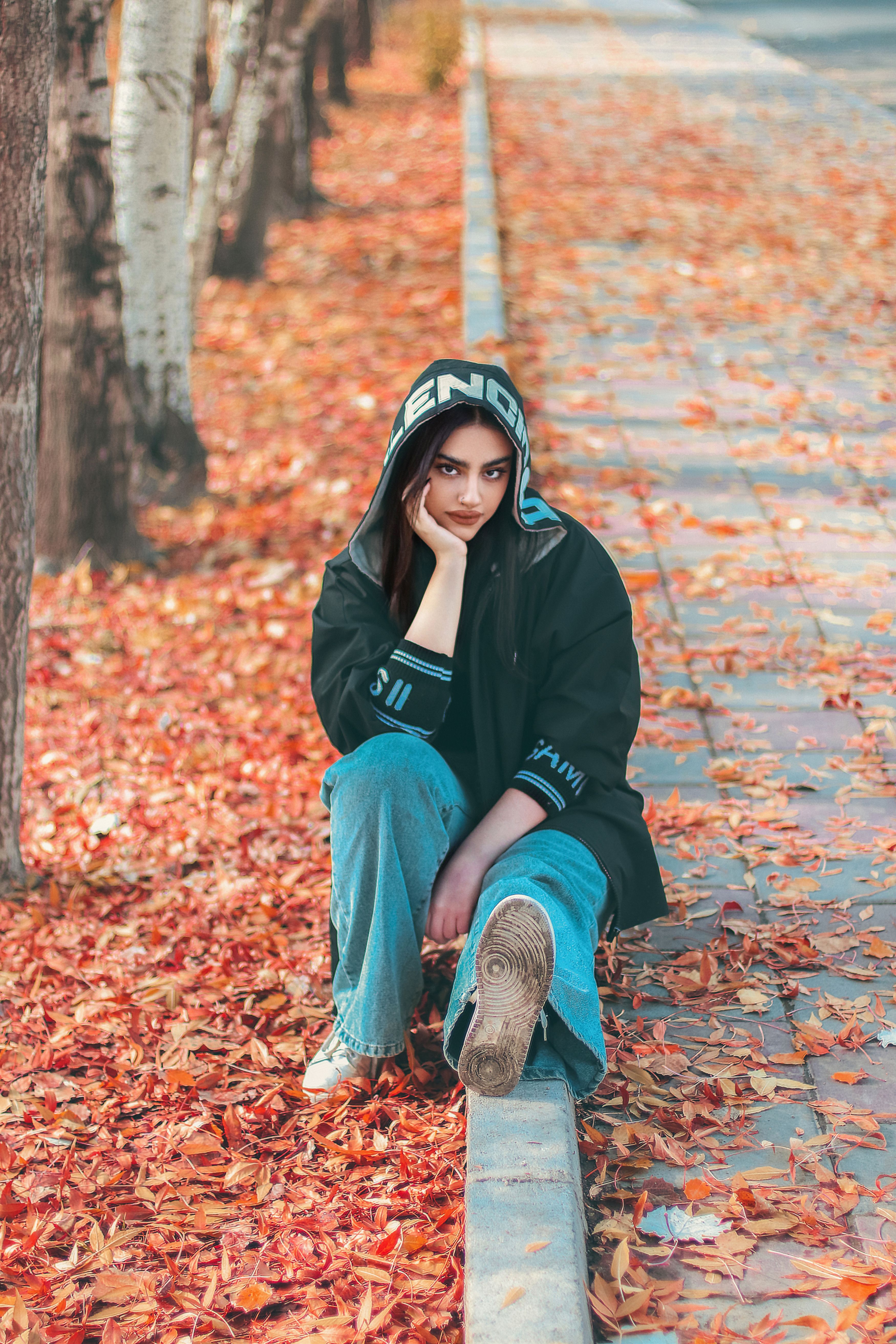Woman Wearing Jumper Sitting on a Pavement · Free Stock Photo