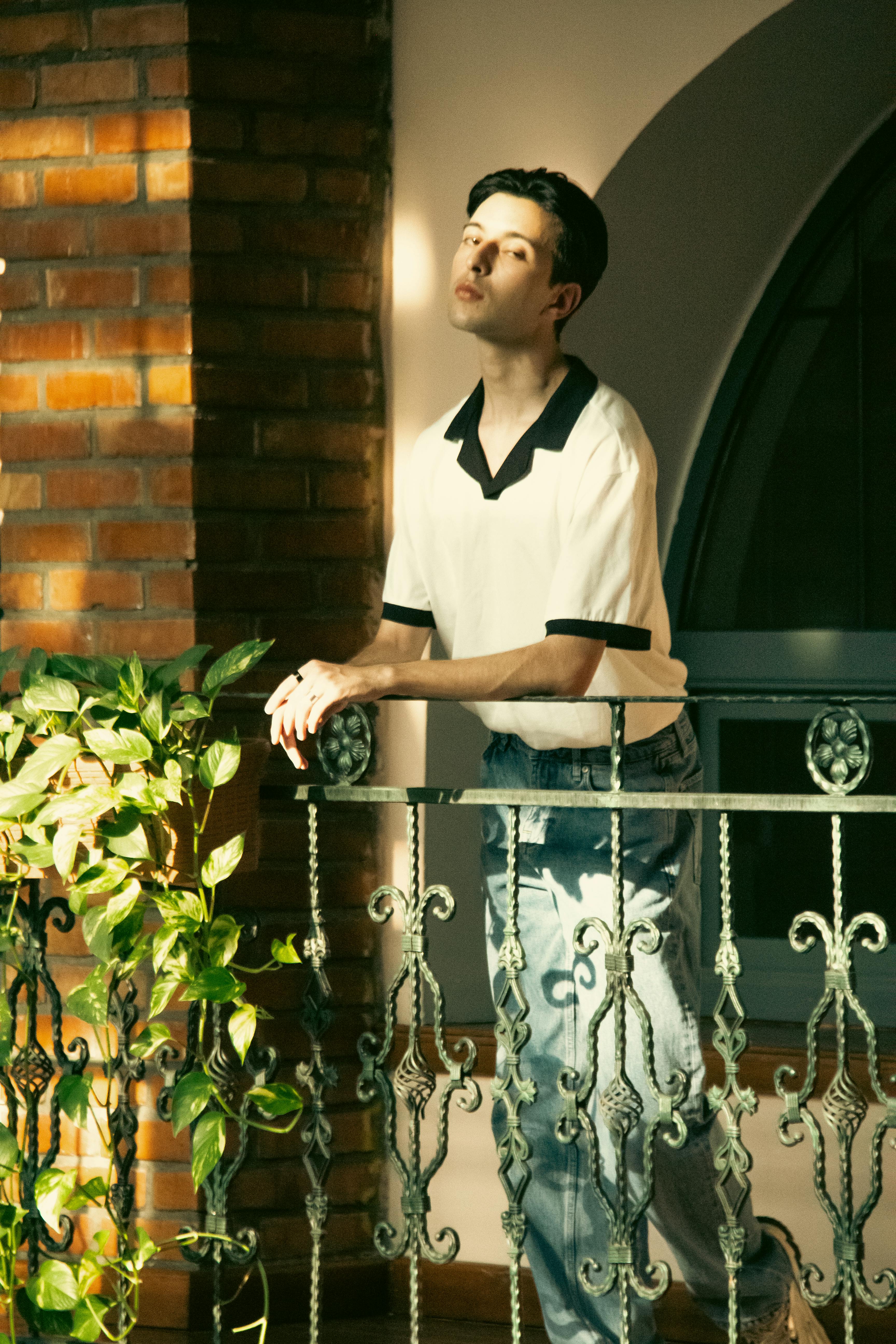 Man Standing by Railing and Posing · Free Stock Photo