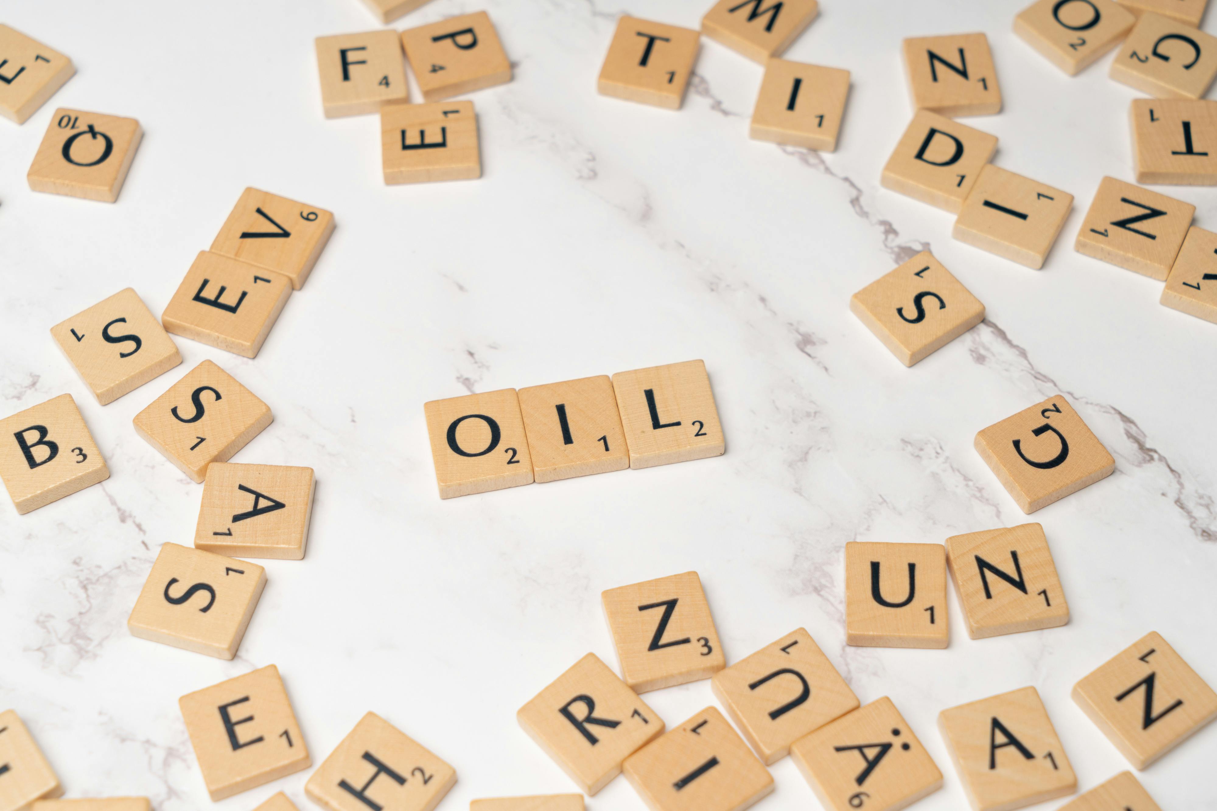 The word oil spelled out in scrabble tiles · Free Stock Photo