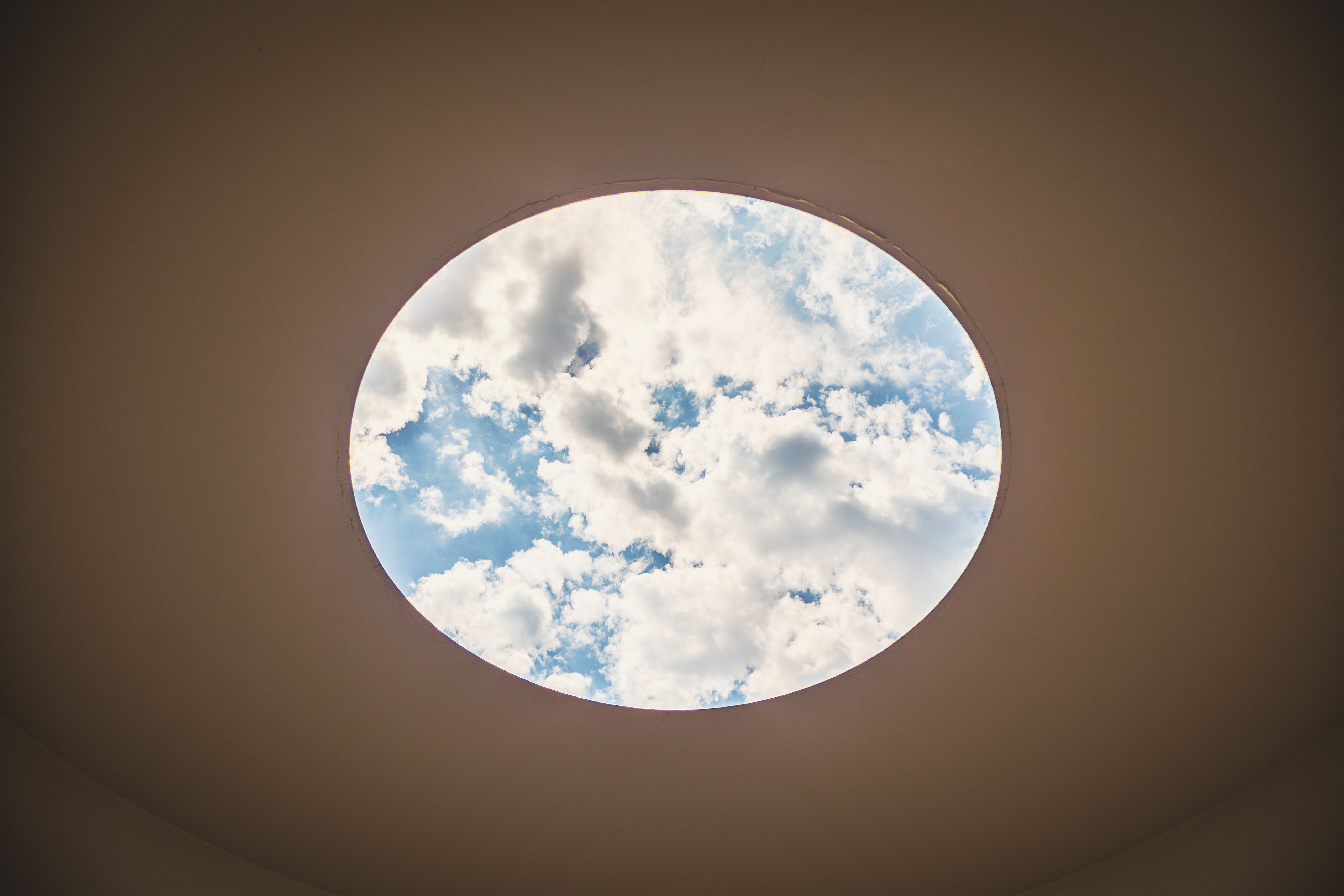 Clouds on Sky behind Circular Window · Free Stock Photo