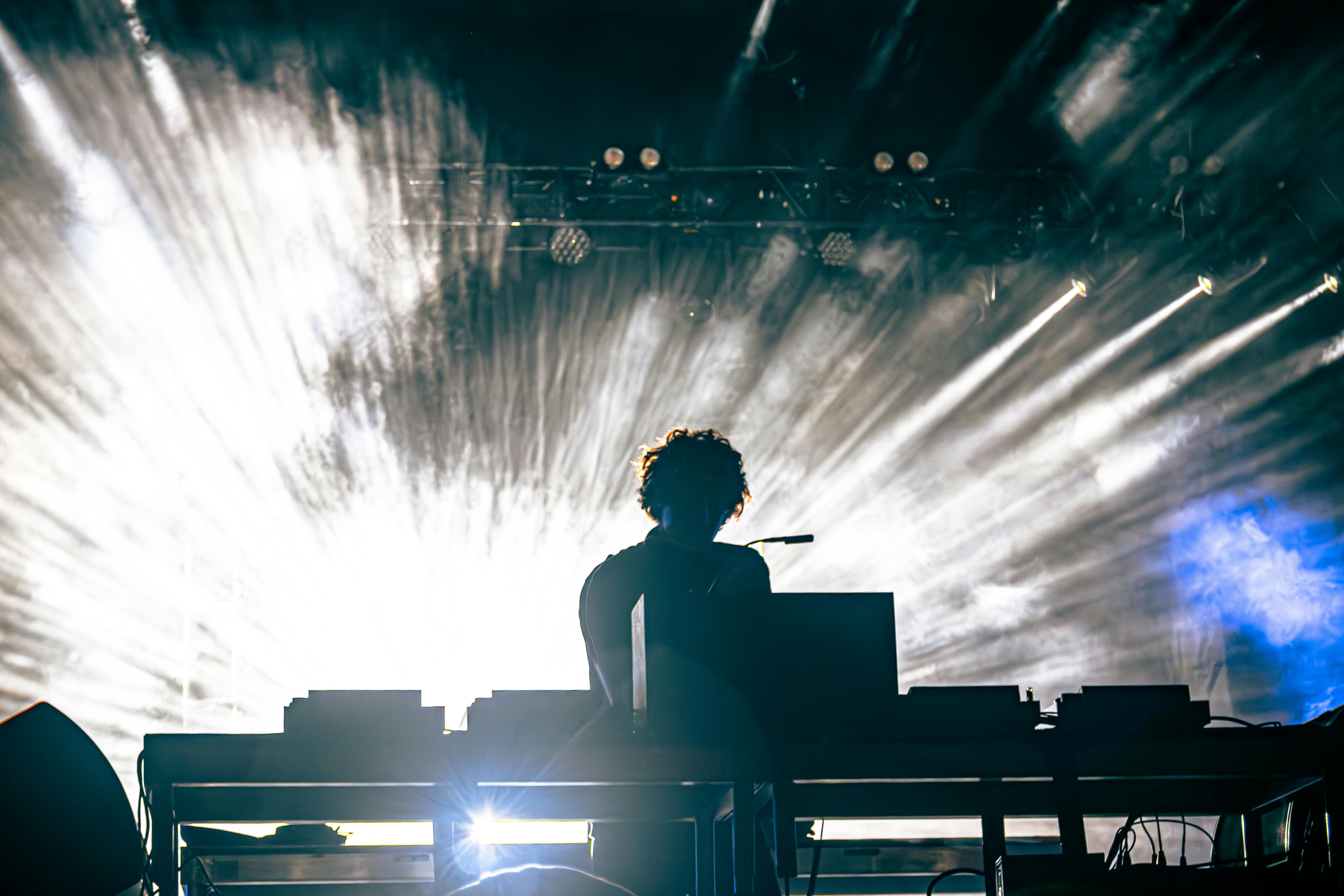 Silhouette of the DJ Standing on Stage · Free Stock Photo
