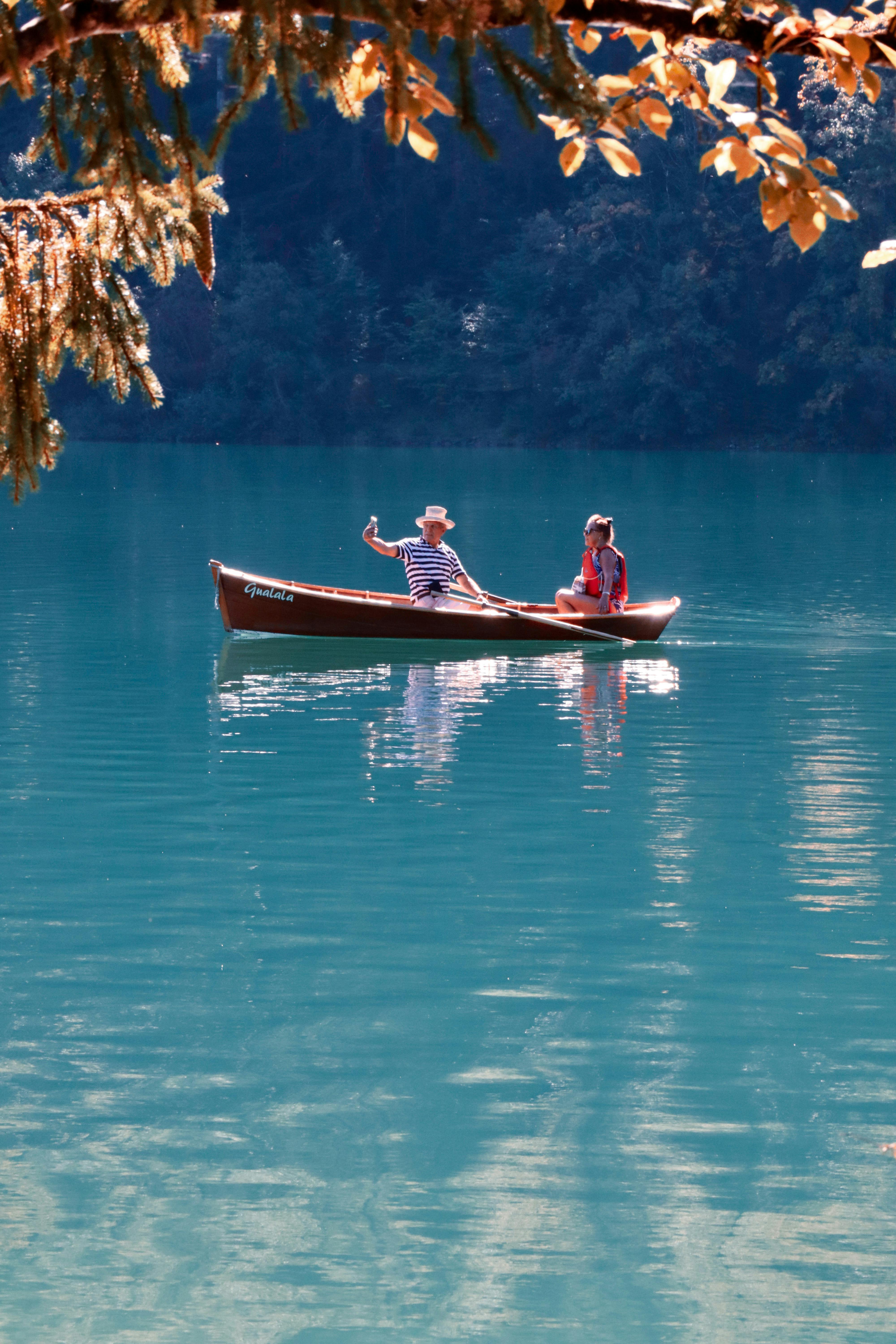 Two People in a Canoe on a Body of Water · Free Stock Photo