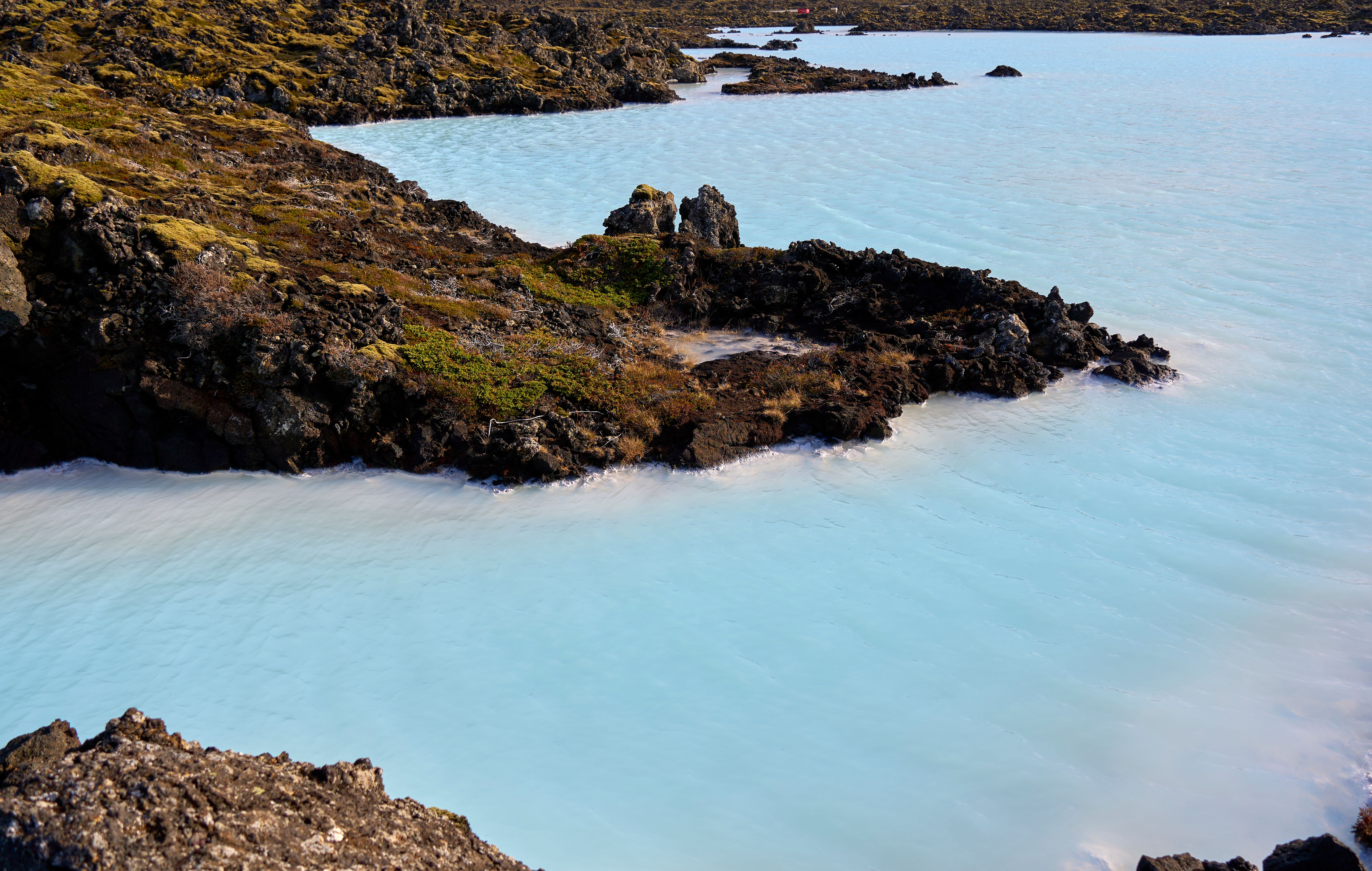 View of a Rocky Shore and Light Blue Water · Free Stock Photo