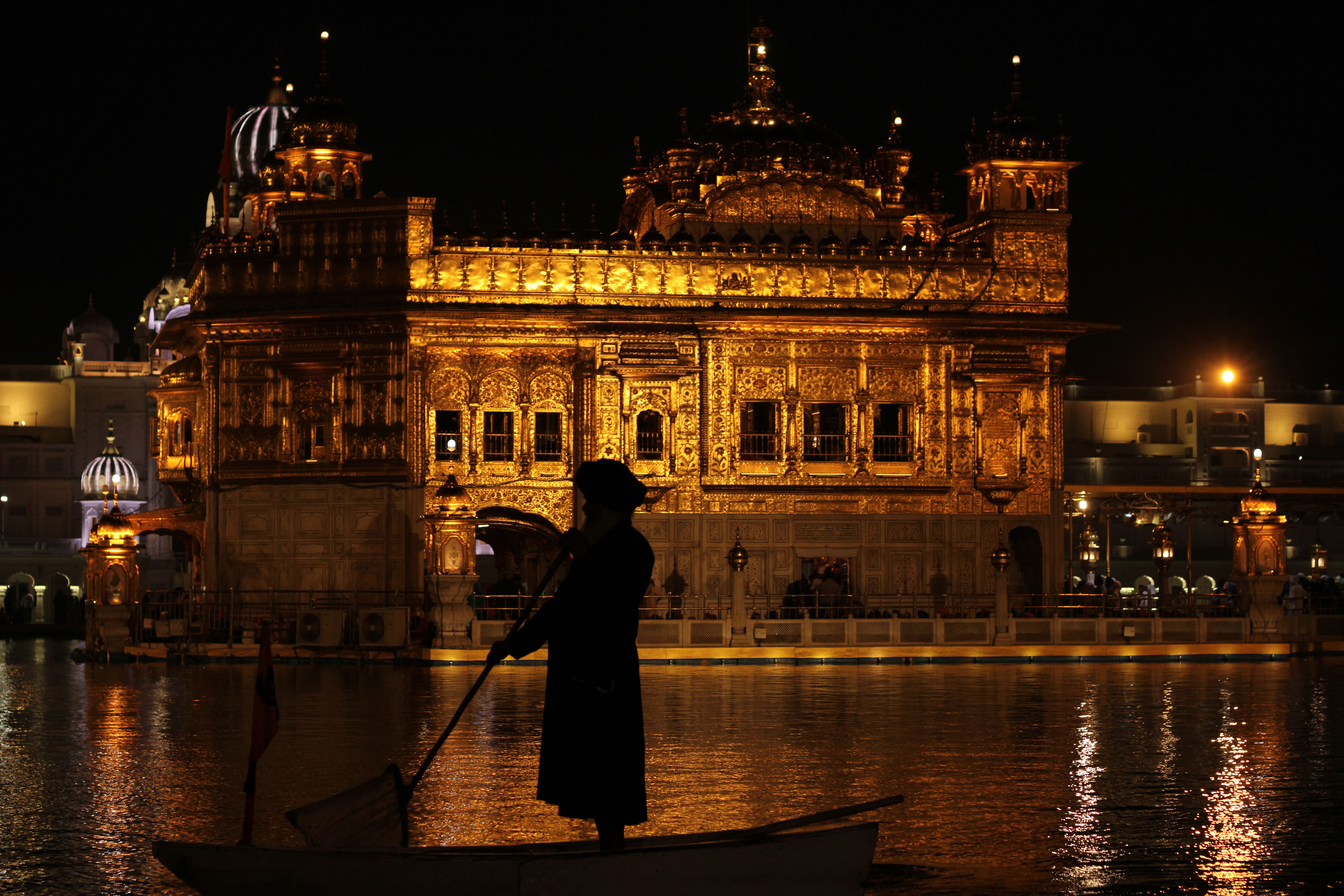 Person on Boat with Golden Temple behind · Free Stock Photo