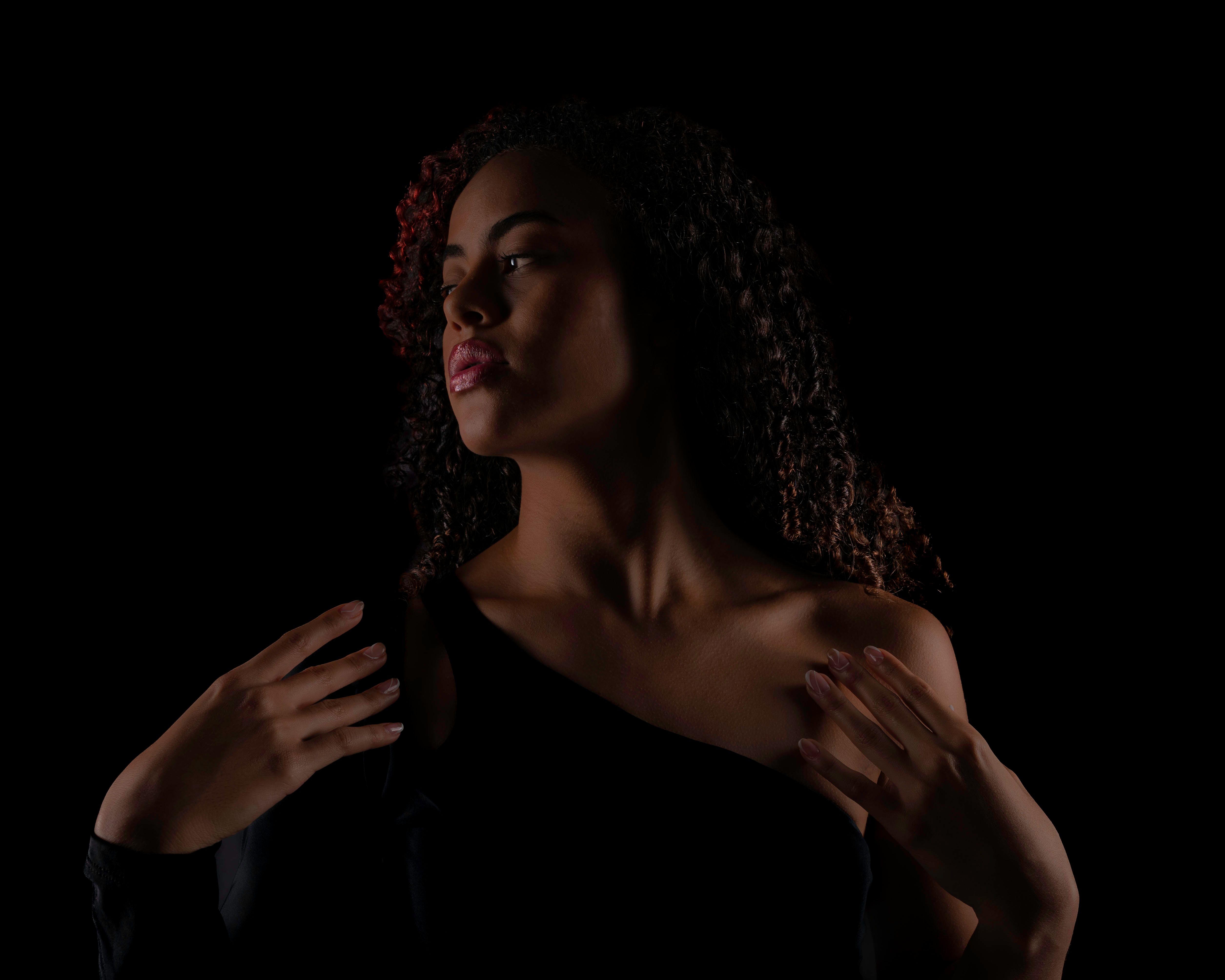 Model Posing on Black Background · Free Stock Photo