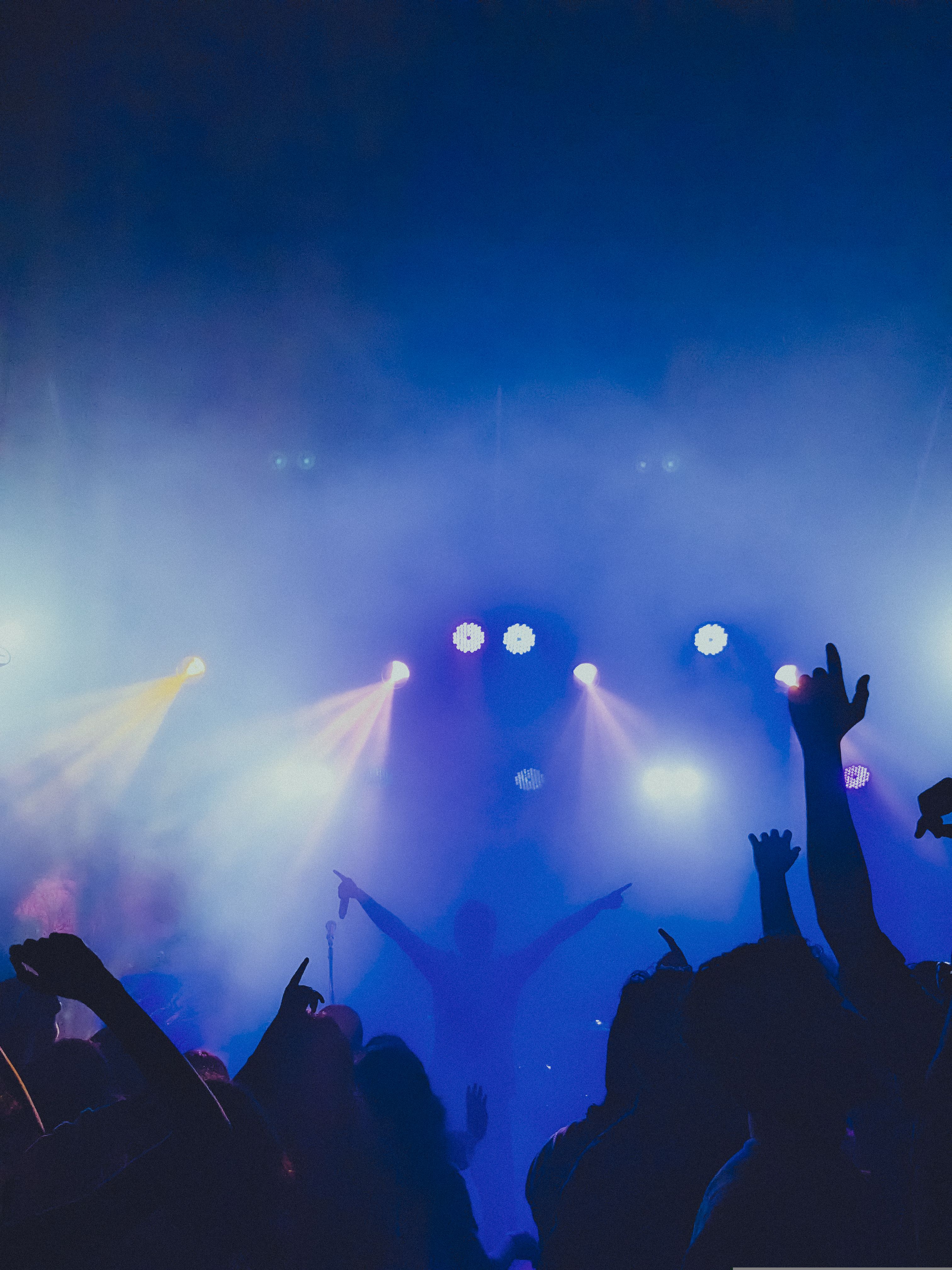 A concert with people in the front and back · Free Stock Photo
