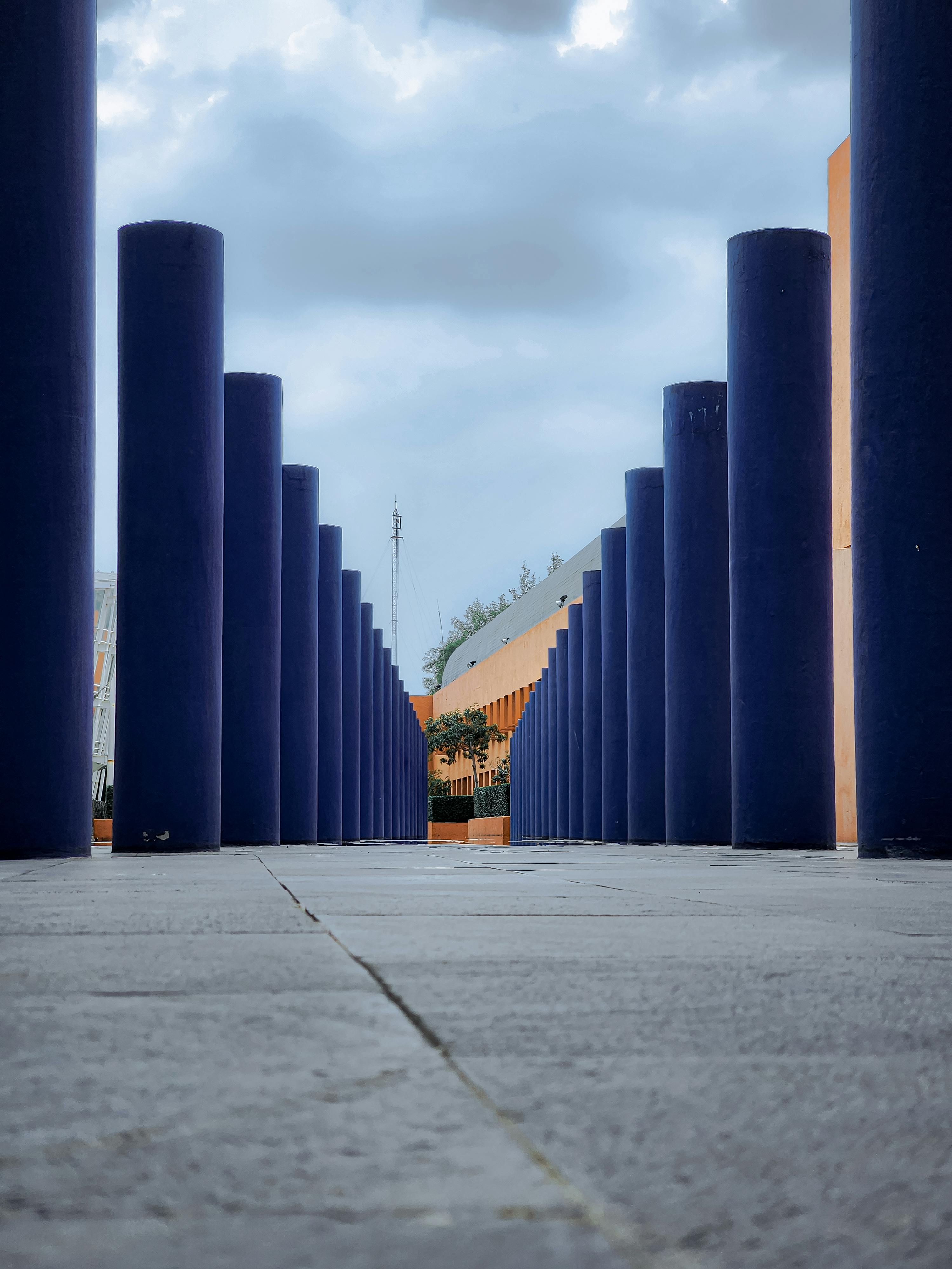 Colonnade of Navy Blue Columns Along the Sidewalk · Free Stock Photo
