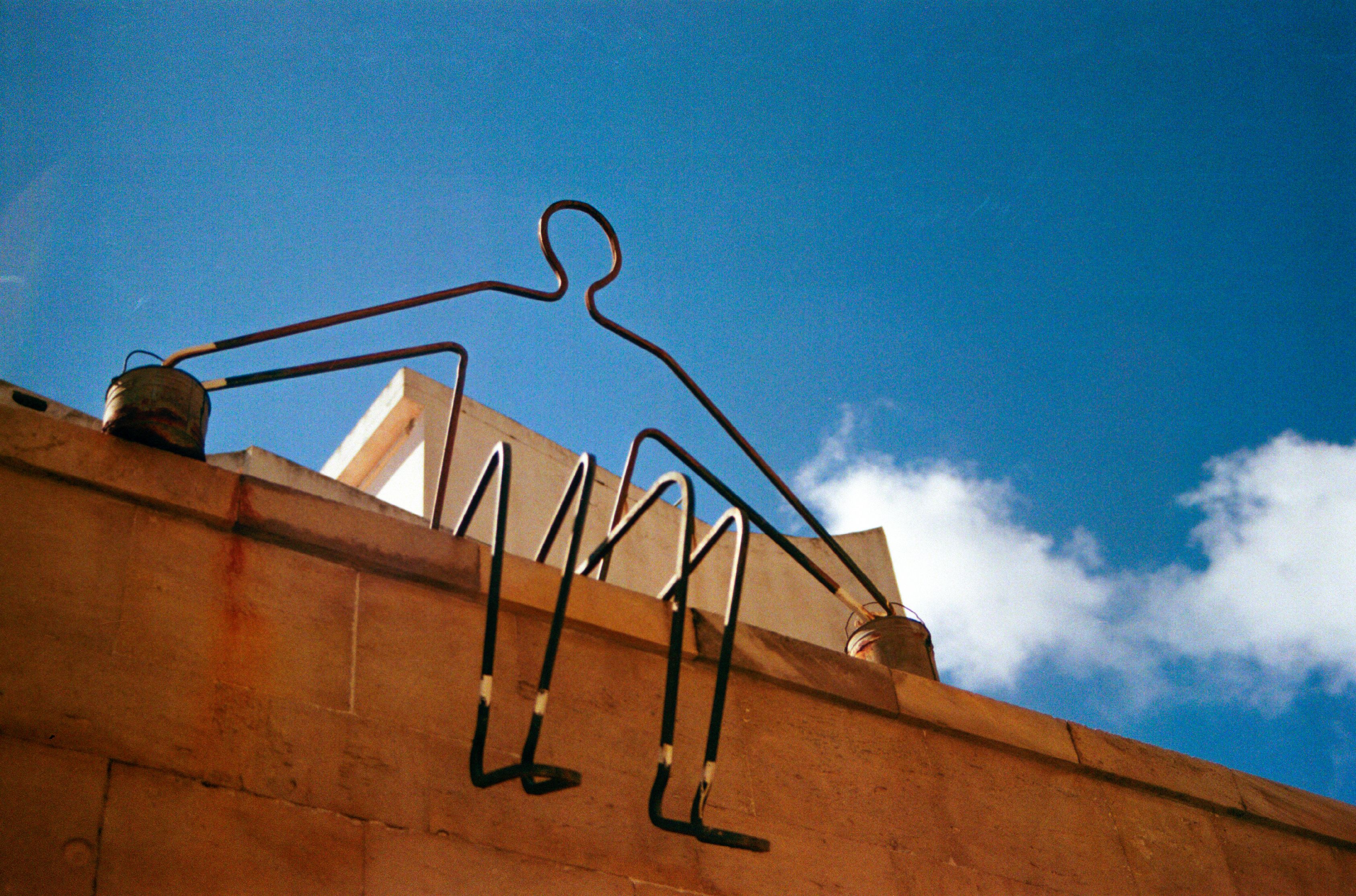 Metal Sculpture on Top of a Building · Free Stock Photo
