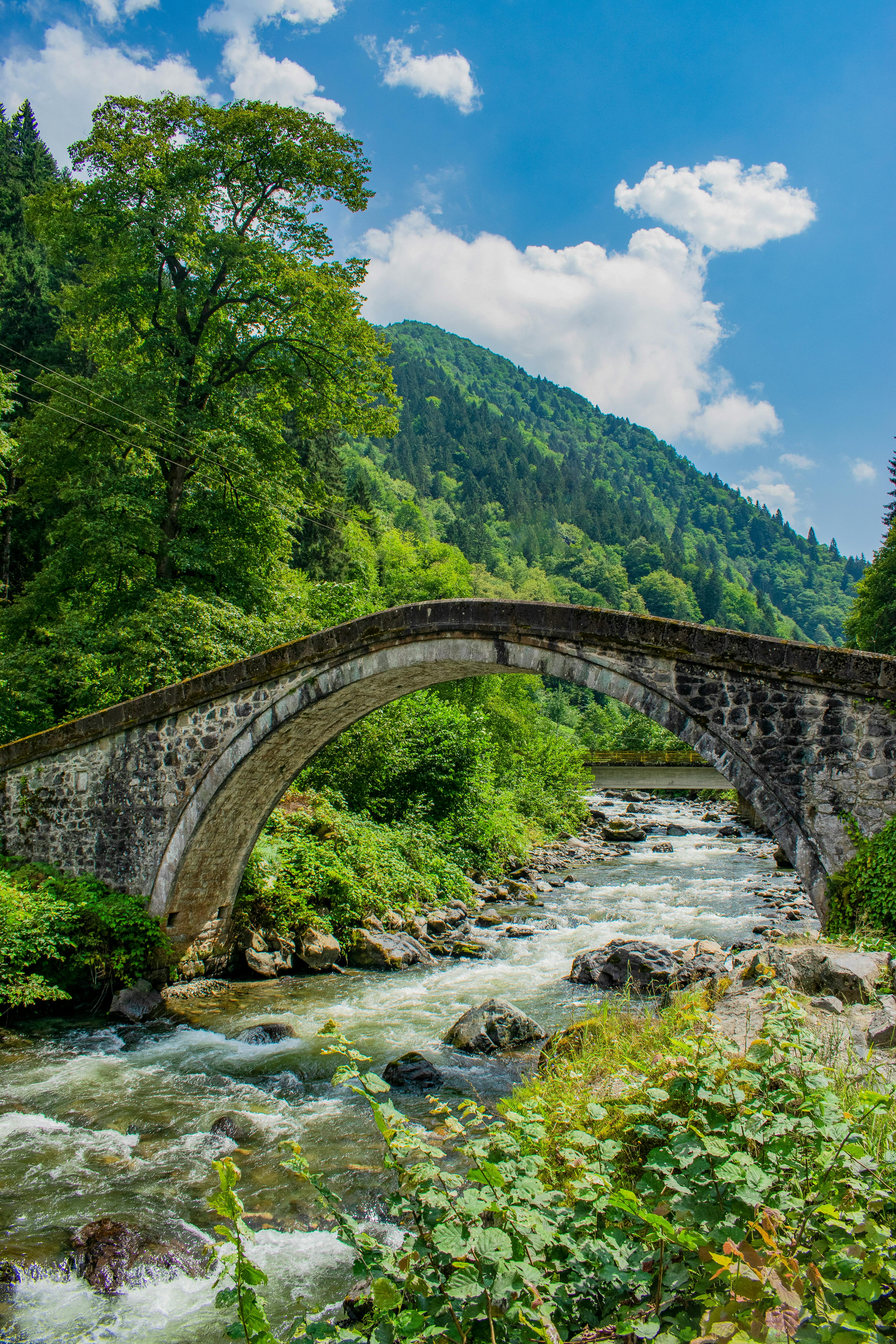 Stone Arch Stone over River in Mountain Landscape · Free Stock Photo