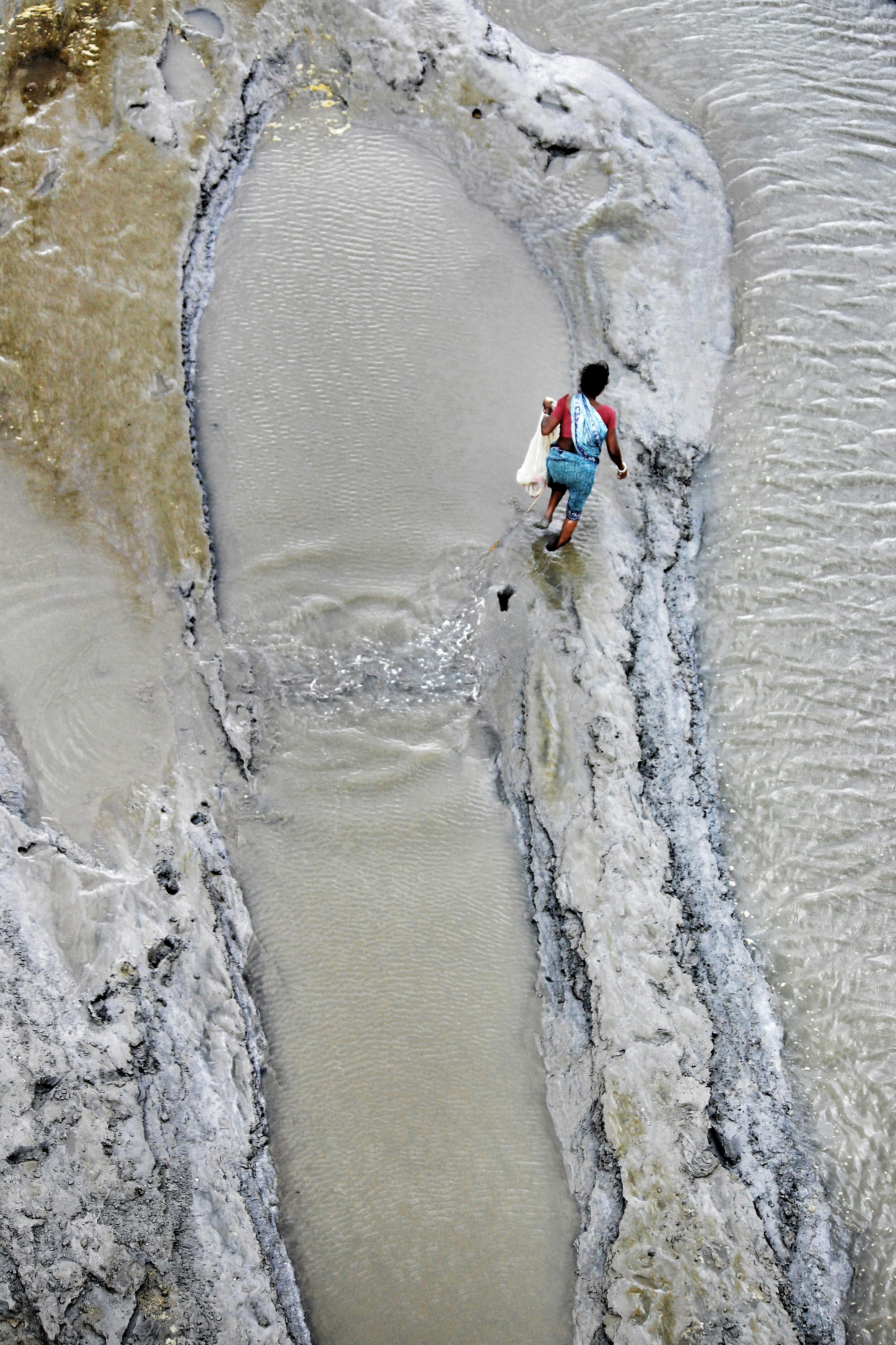 Aerial View of a Person Walking on a Beach Leaving Footprints Behind ...