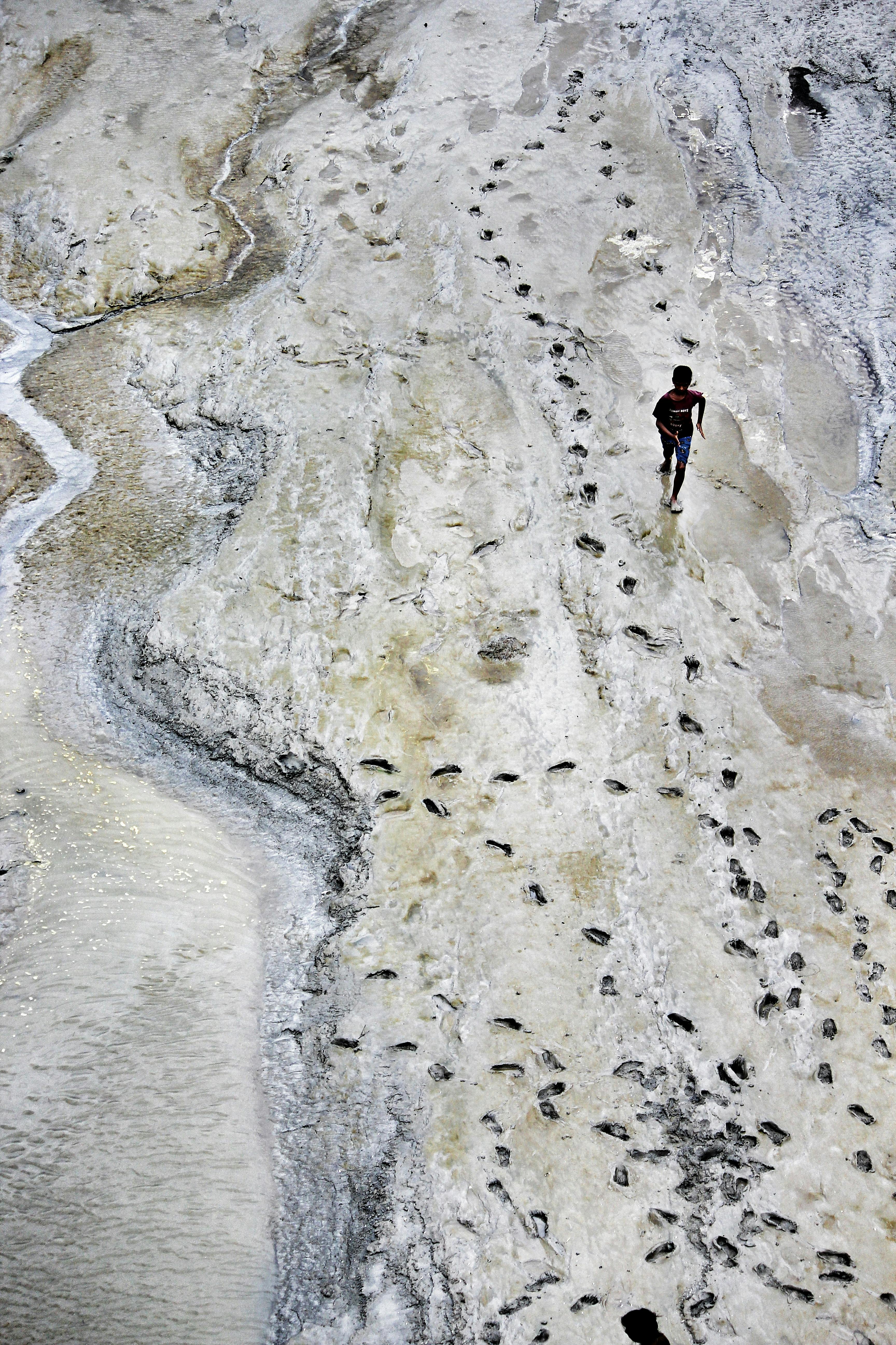 Boy Running in Mud · Free Stock Photo