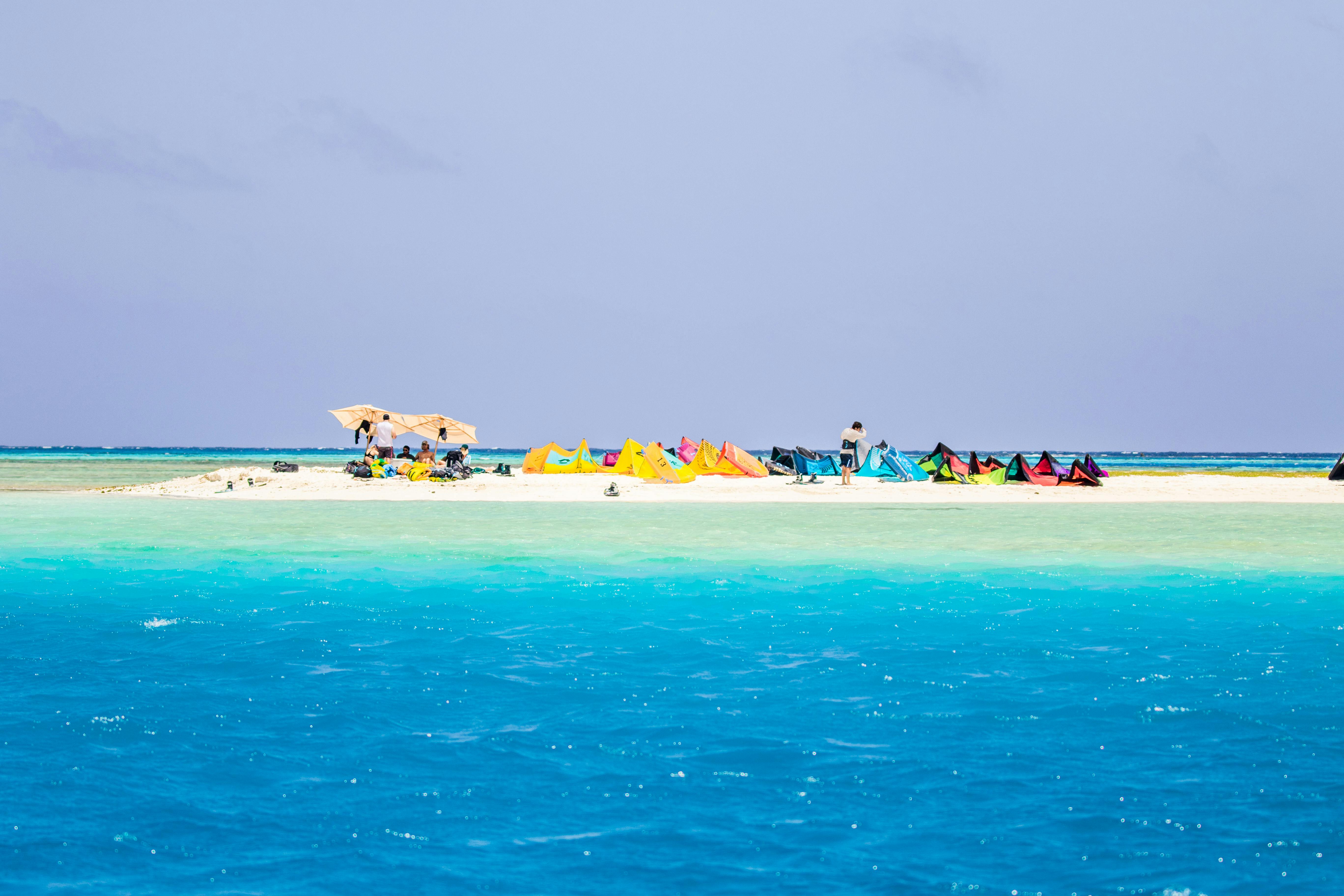 Colorful Tents Set on Small Sandy Peninsula in the Turquoise Waters of ...