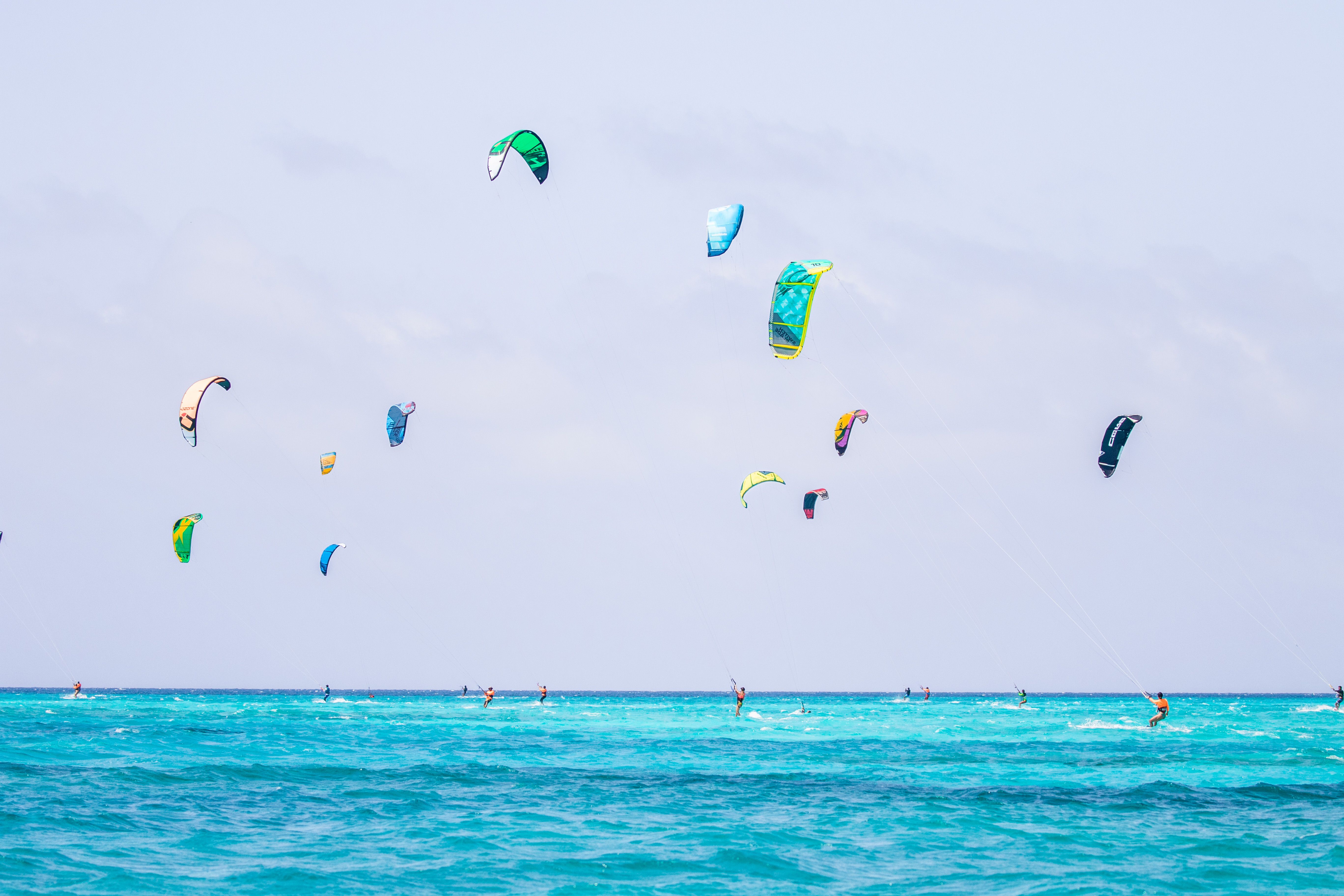 Colorful Power Kites of a Group of Kiteboarders Over the Turquoise Sea ...