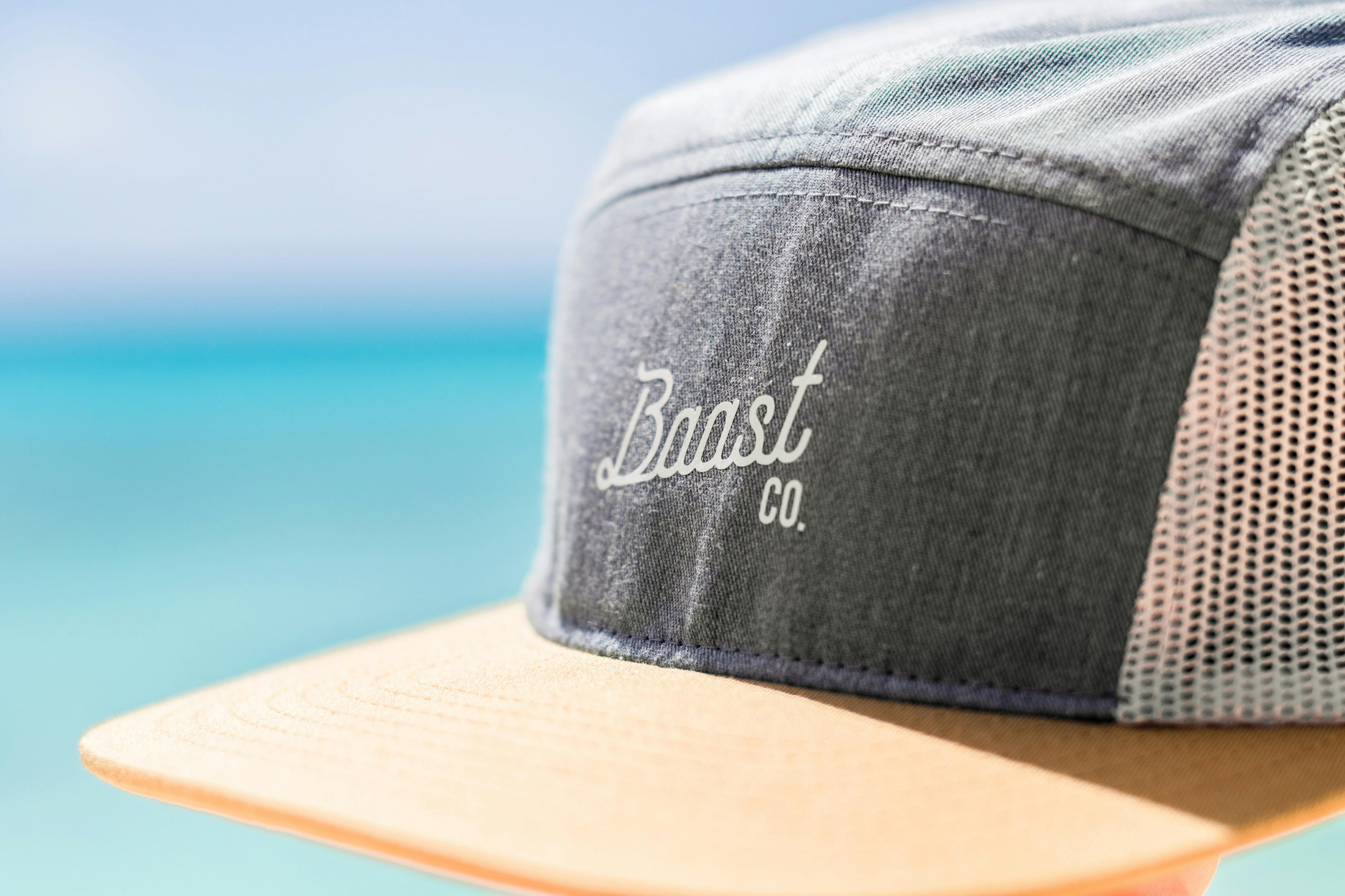 Gray Baseball Cap With a Yellow Visor Baast Co · Free Stock Photo