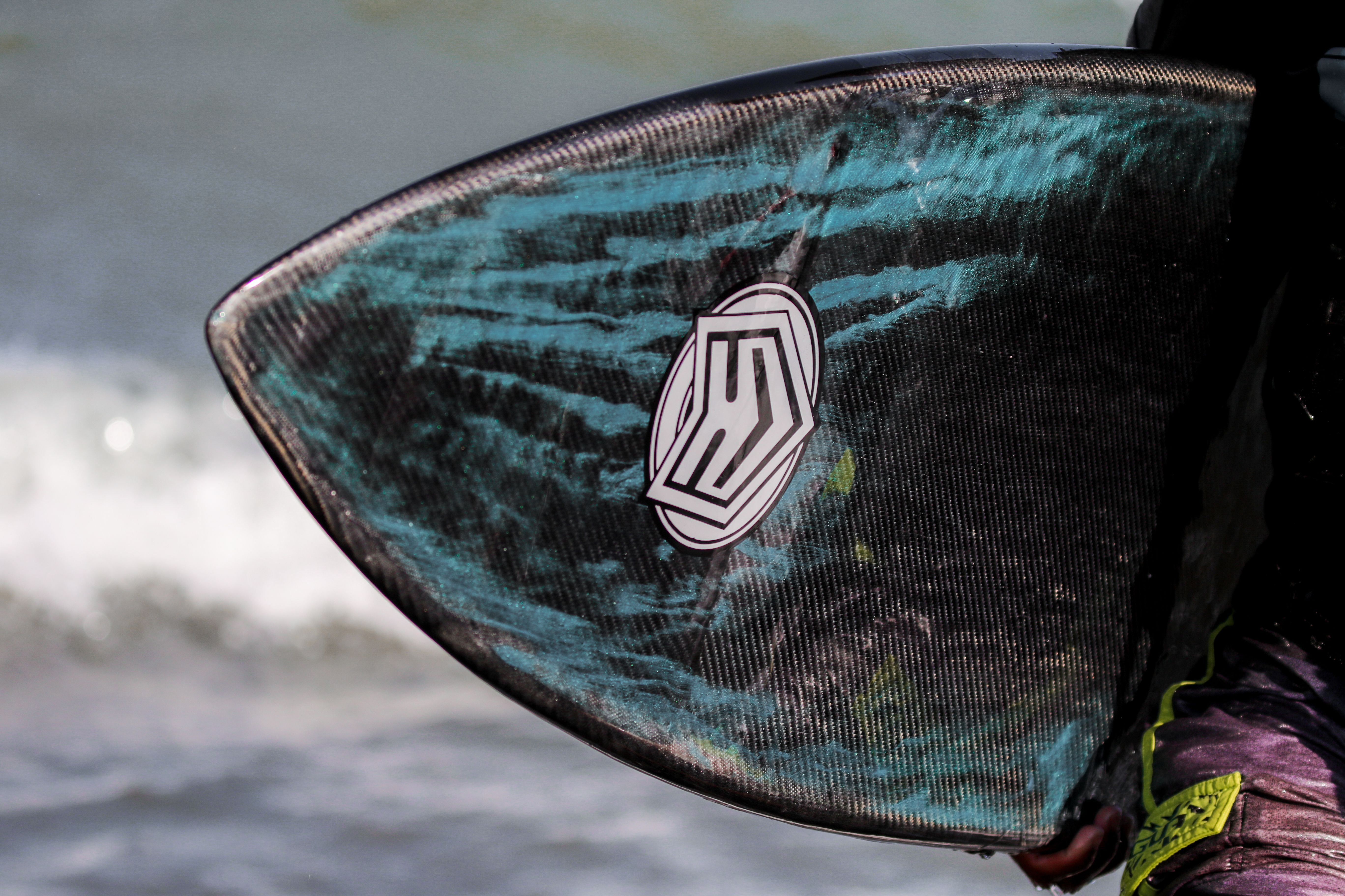 Person Carrying a Surfboard on a Beach · Free Stock Photo