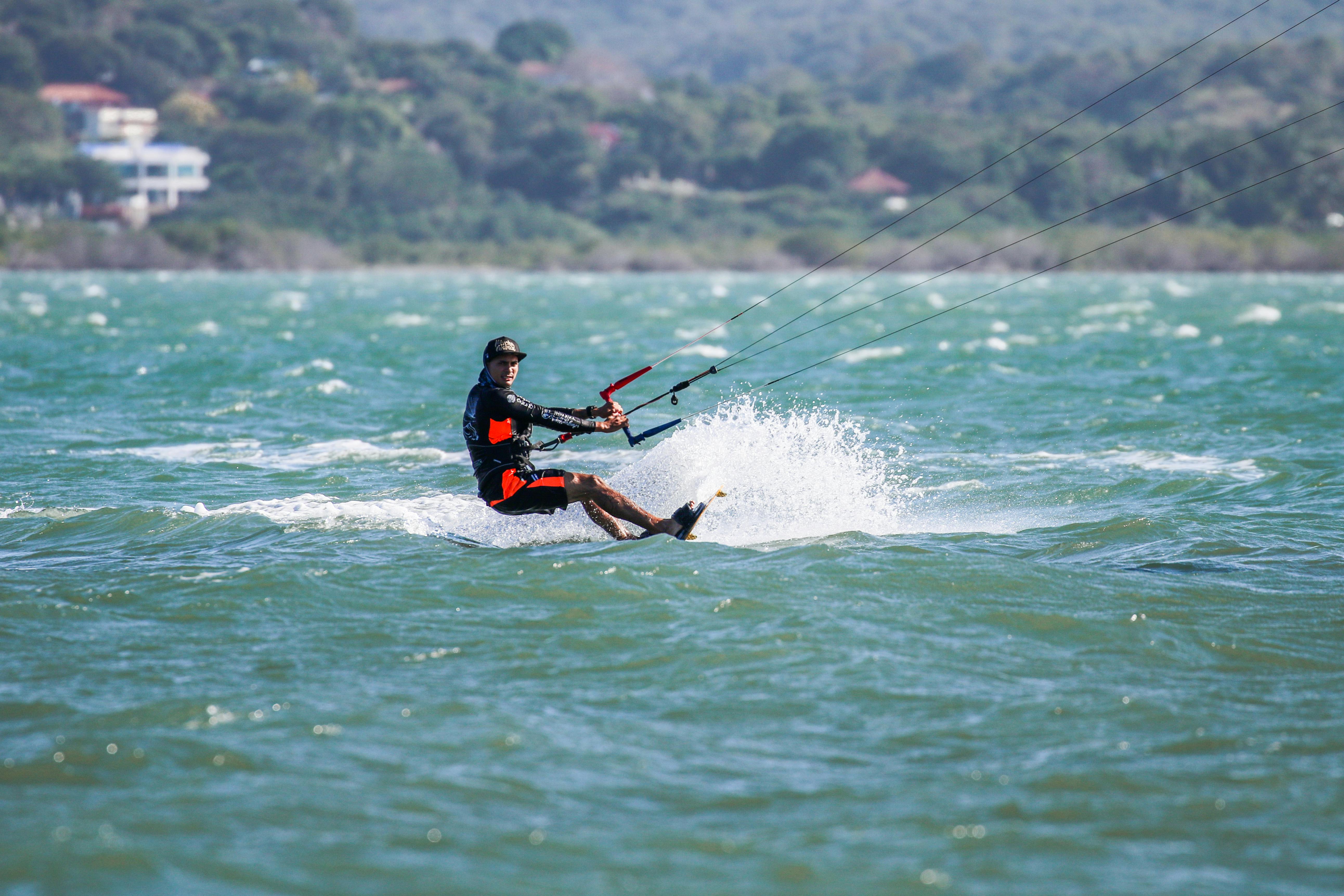 Boy With a Kitesurfing Board and Harness on the Beach Holding a Power ...