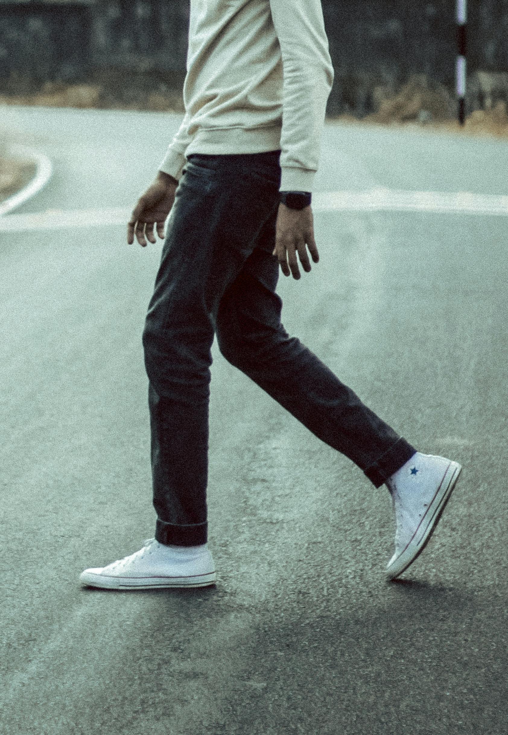 Man in Jeans and Sneakers Walking Down the Street · Free Stock Photo
