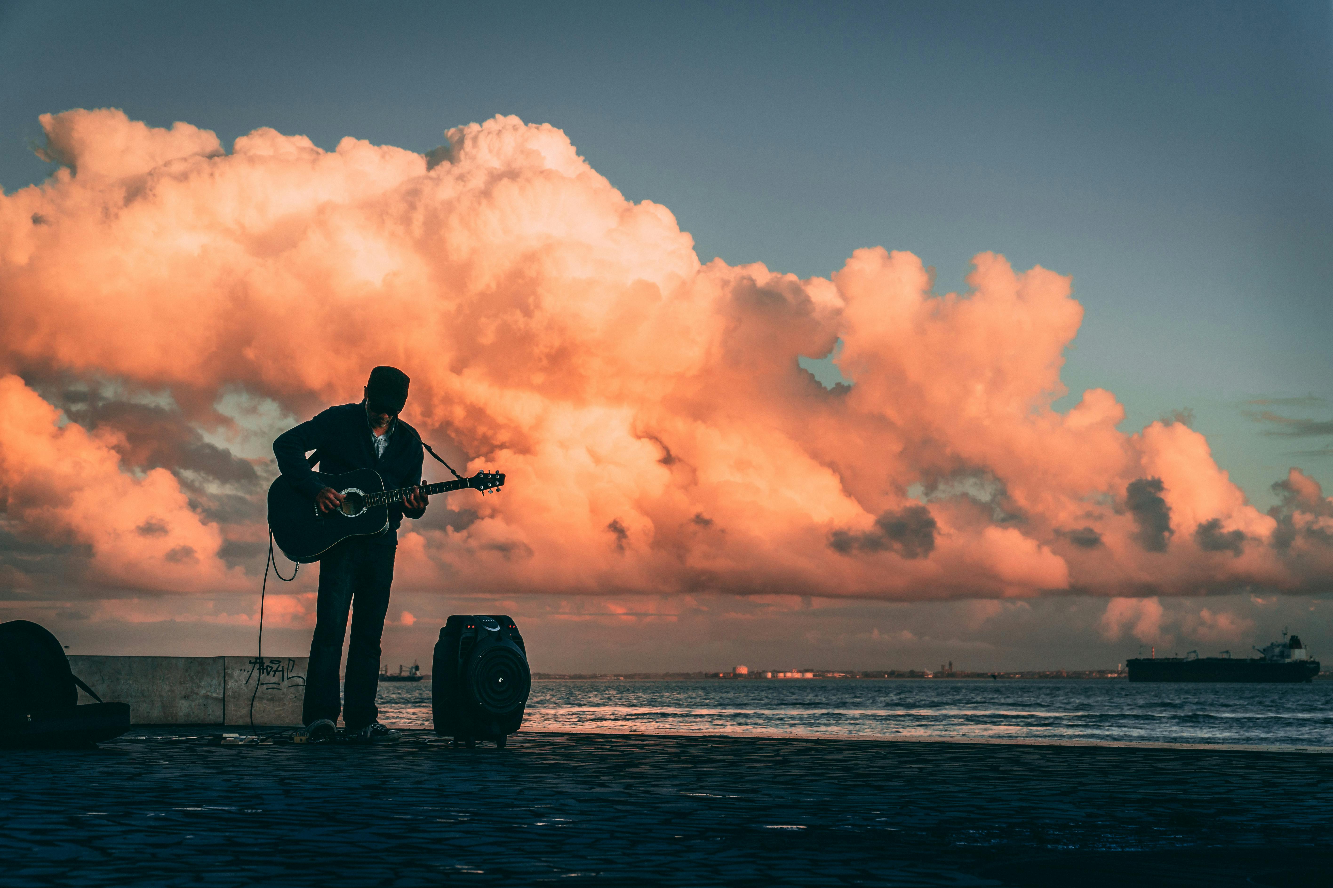 Man Playing Guitar on Beach at Sunset · Free Stock Photo