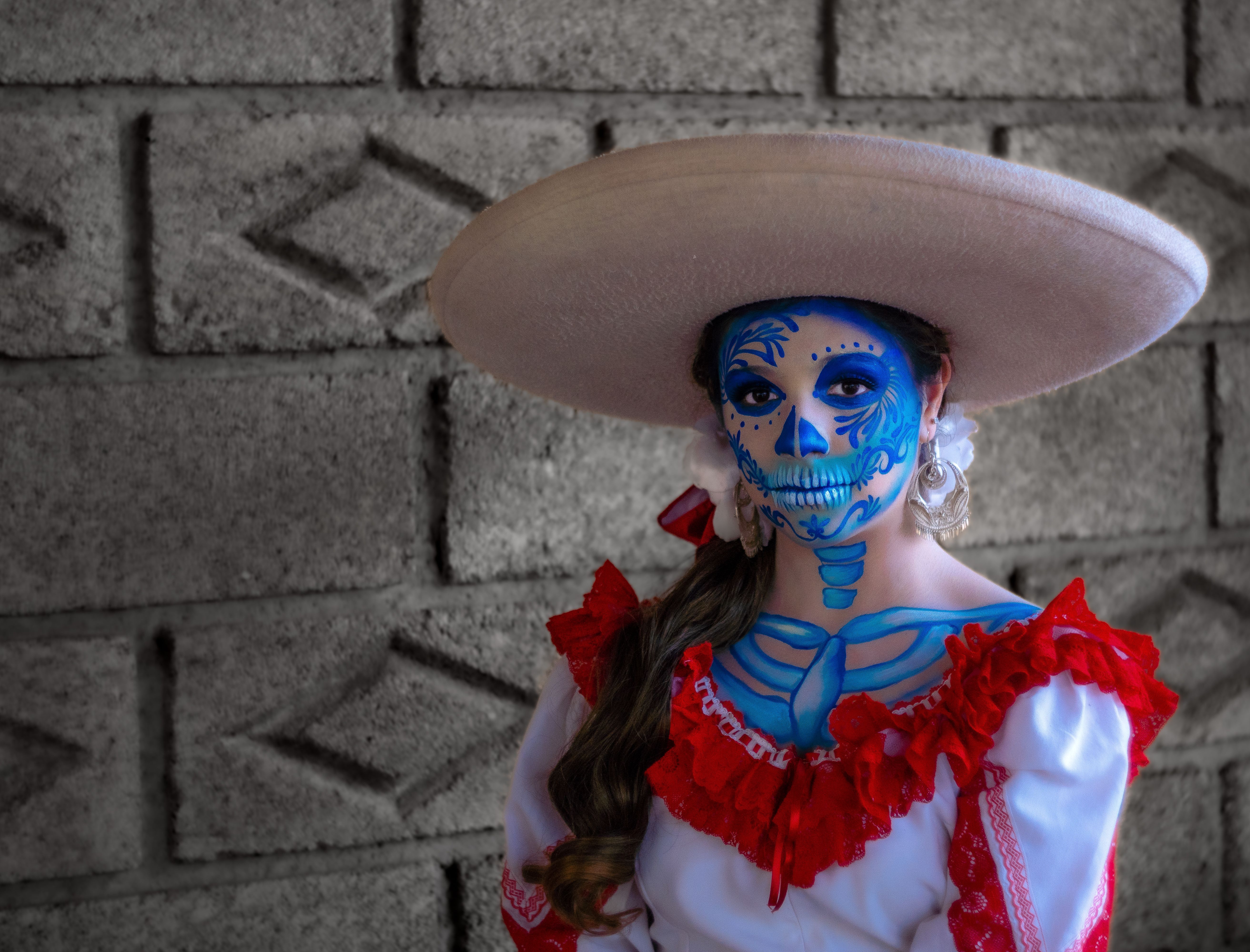 Woman Wearing a Traditional Mexican Death Costume, Posing by a Wall ...