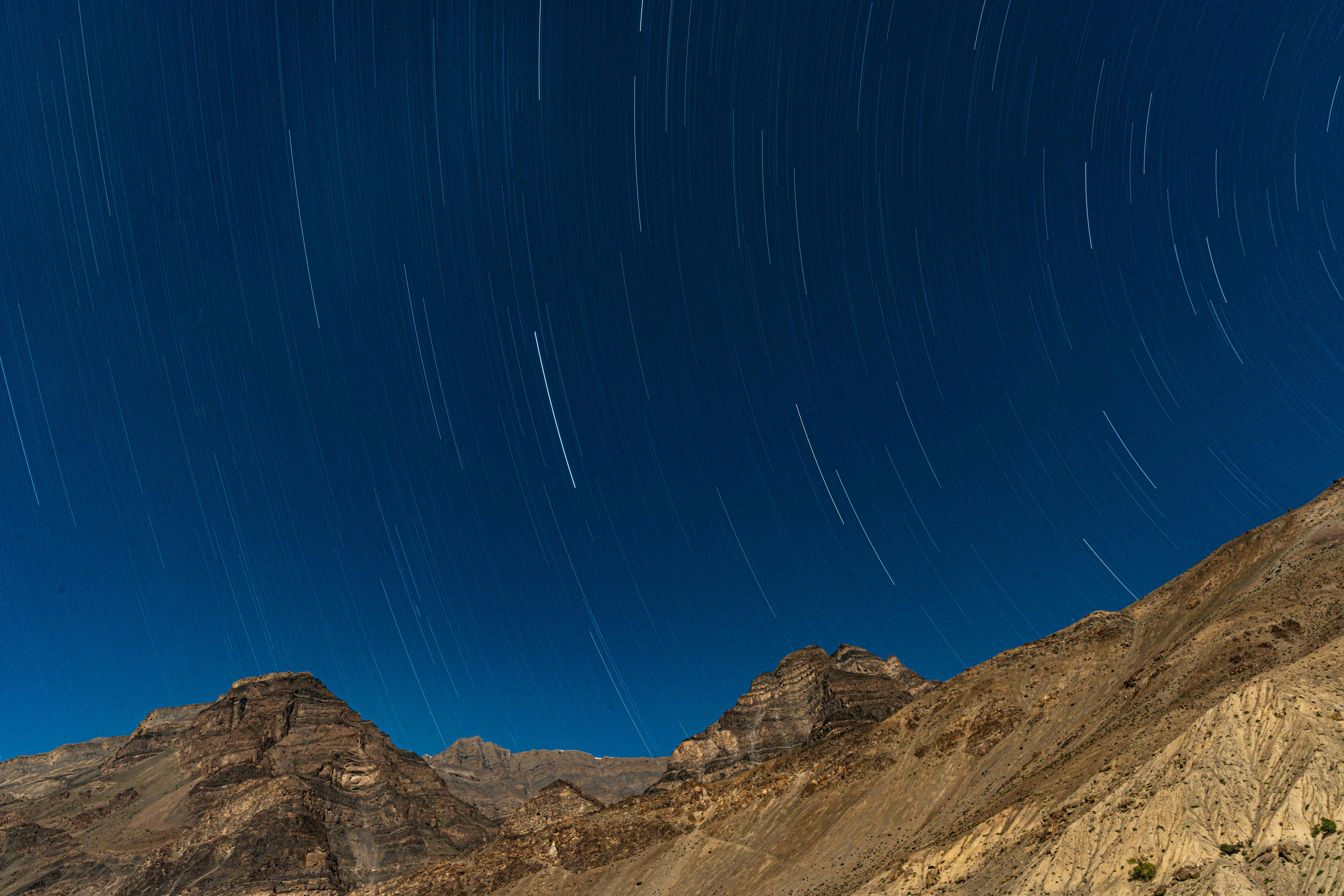 Lights on Clear, Night Sky over Barren Rock Formations · Free Stock Photo